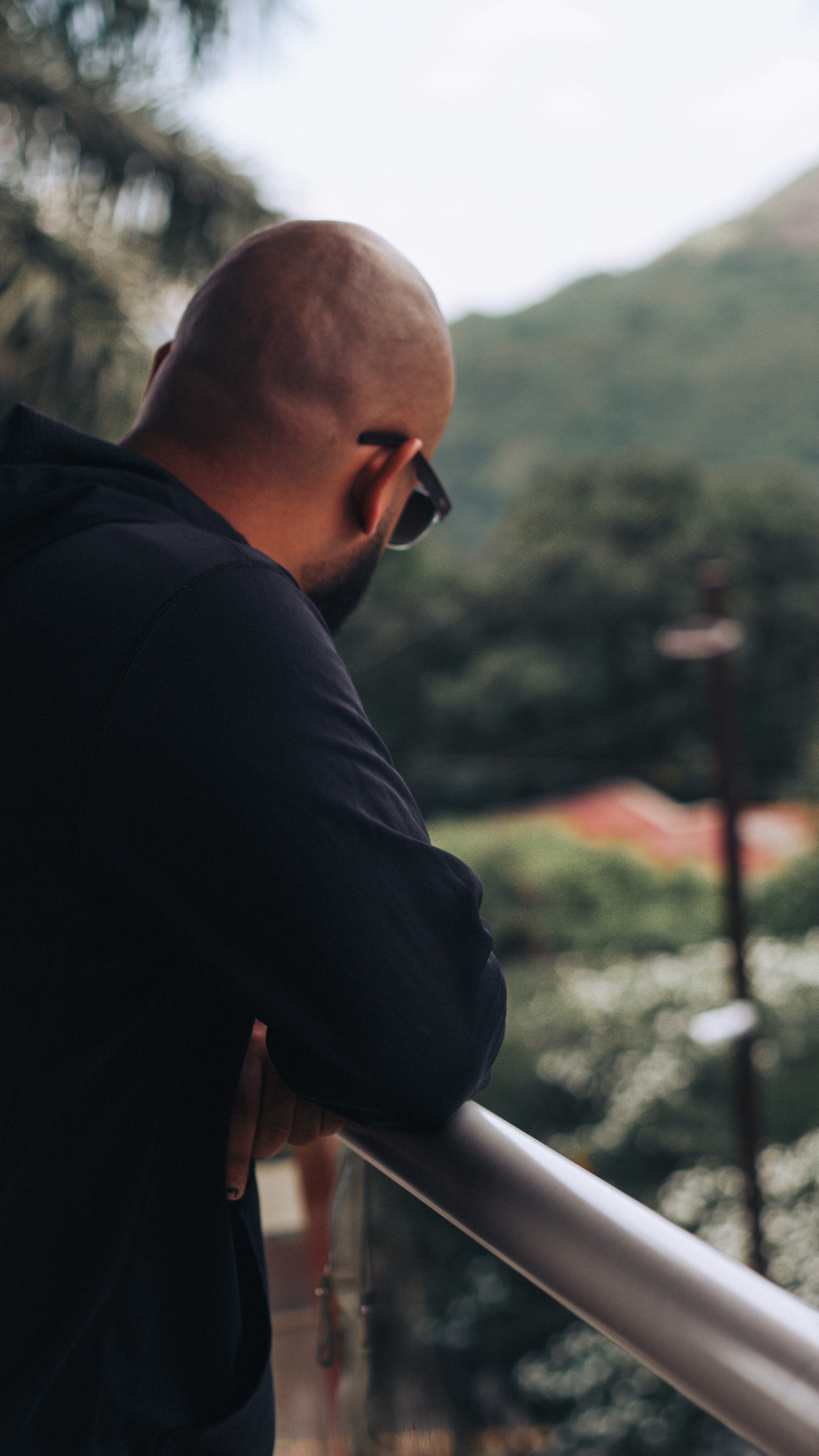 Balcony Reverie: A Quiet Moment Gazing Toward the Mountain Veil