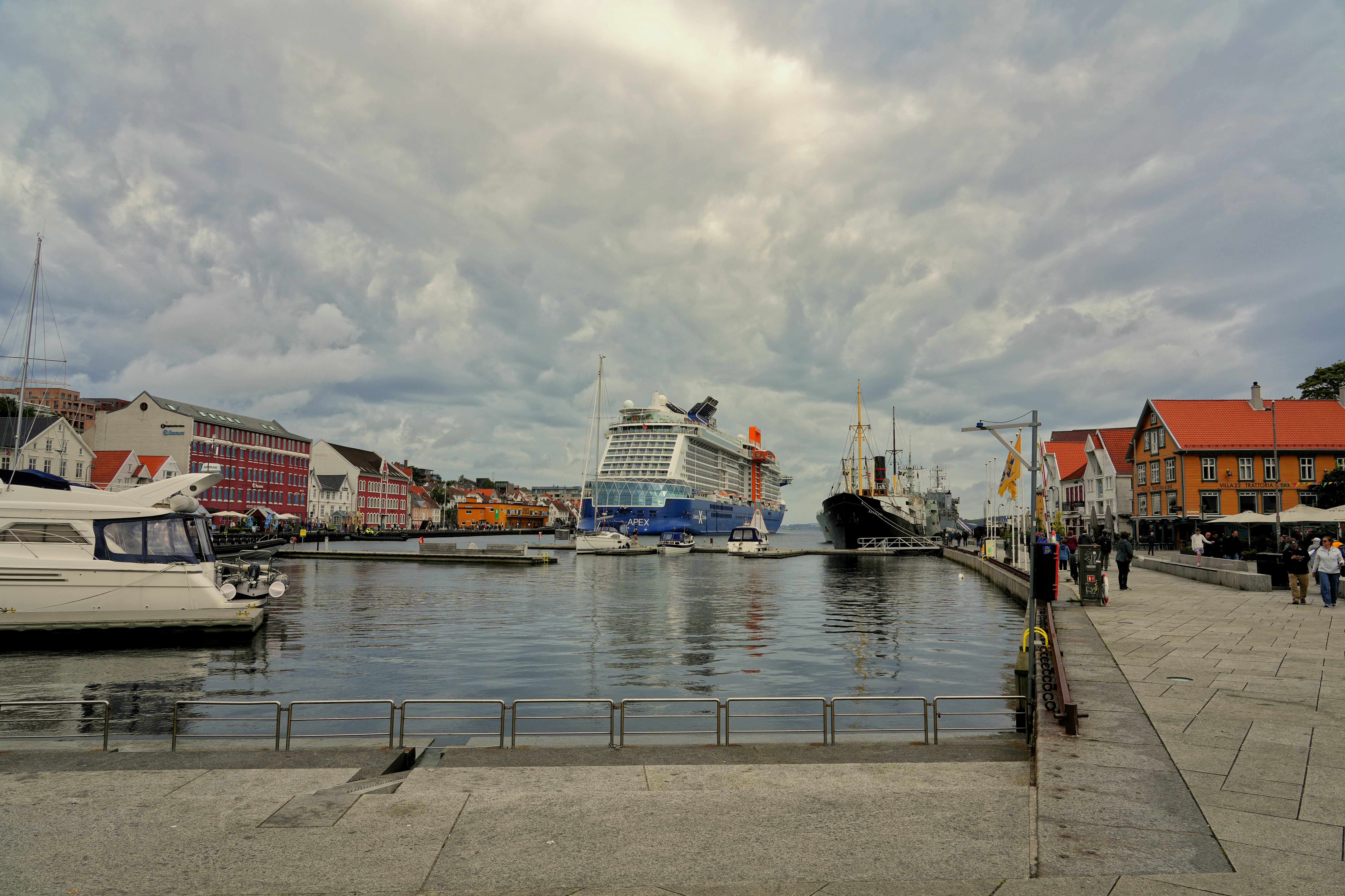 Port of Stavanger, Norway | Boats docked in a harbor with buildings and cloudy sky.