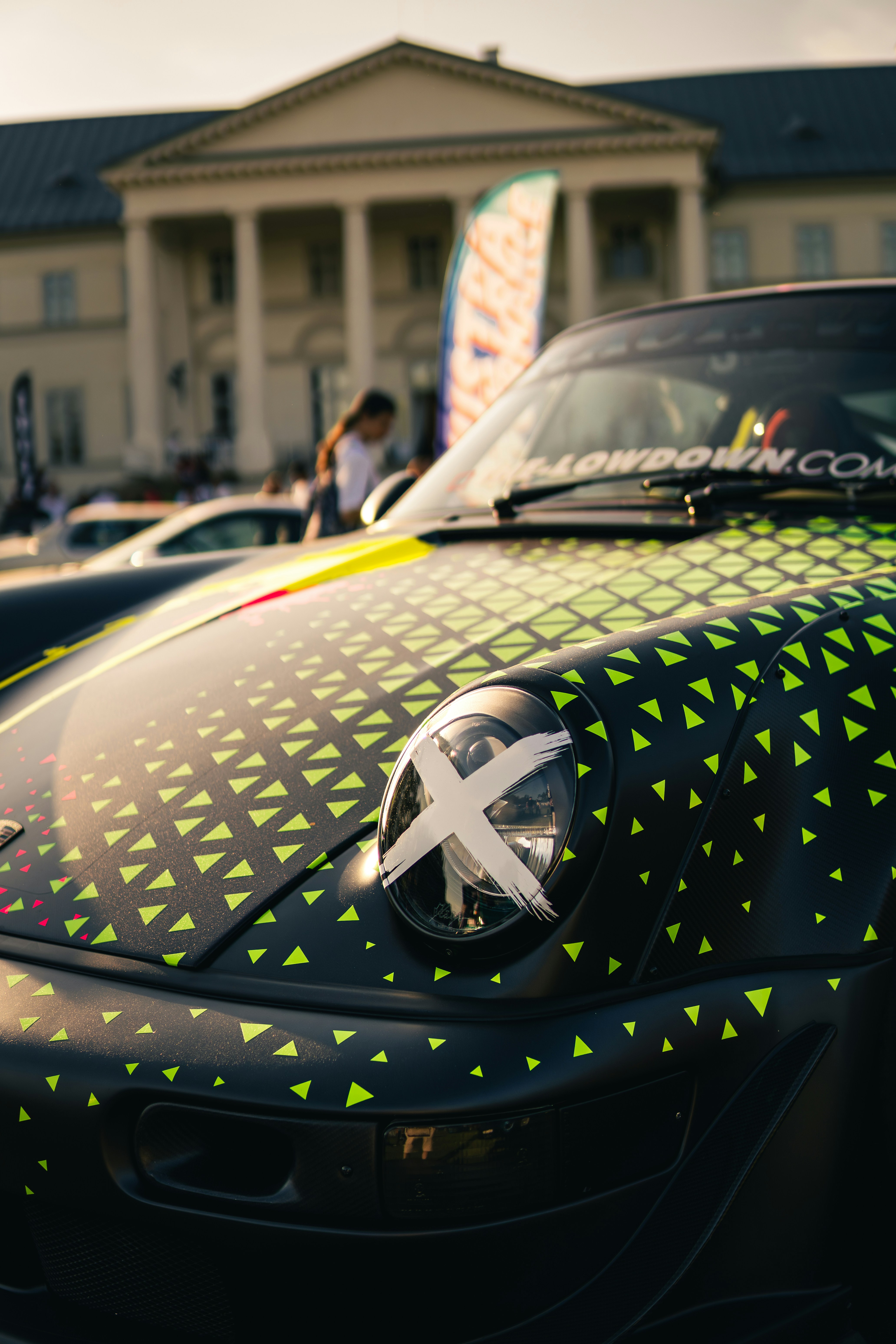 Neon Triangles on chrome: a close-up of a race-inspired hood