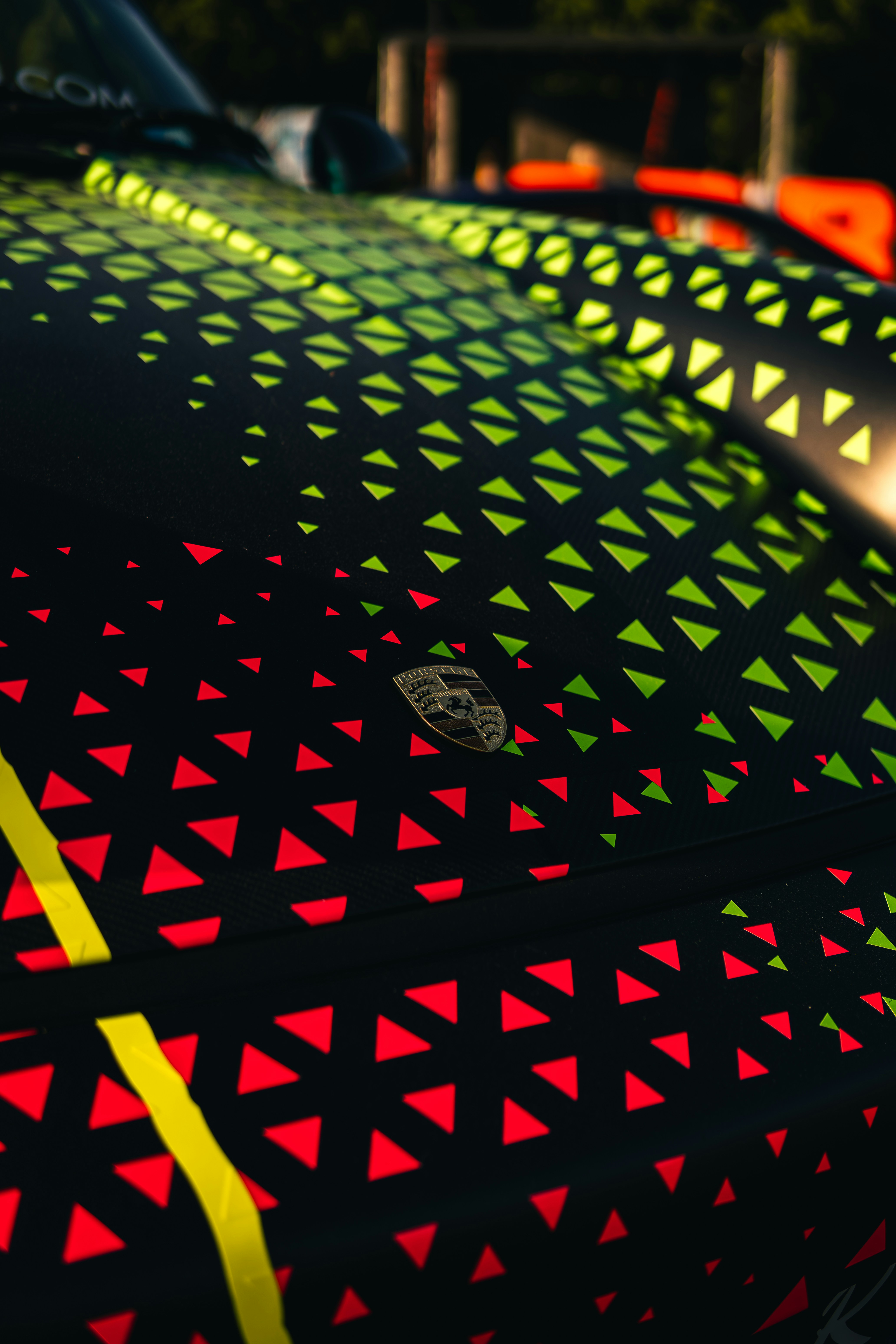 Geometric Neon Mosaic Drapes a Porsche Hood