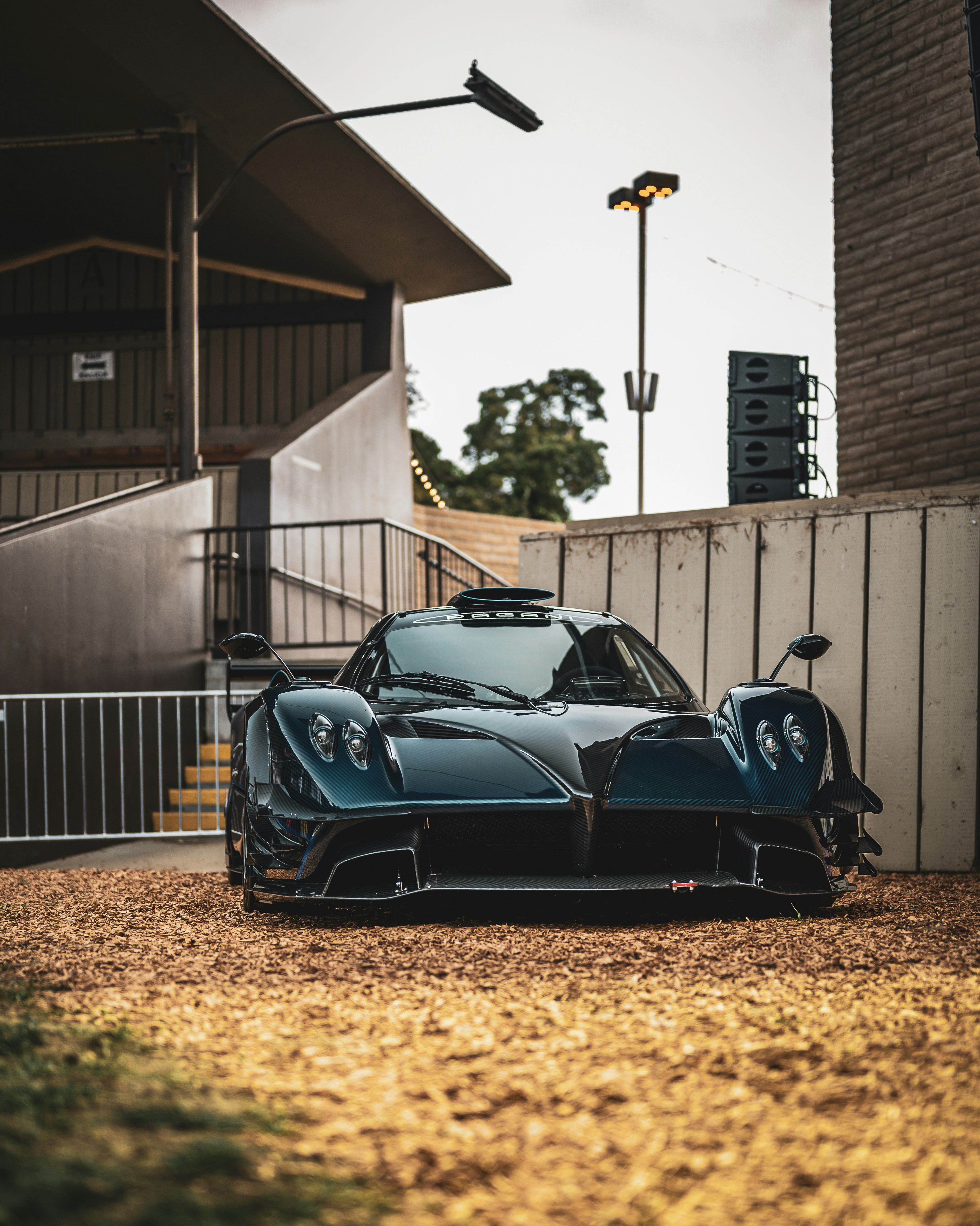 Noir Velocity: Front-Face Power of a Sleek Hypercar in a Quiet Courtyard