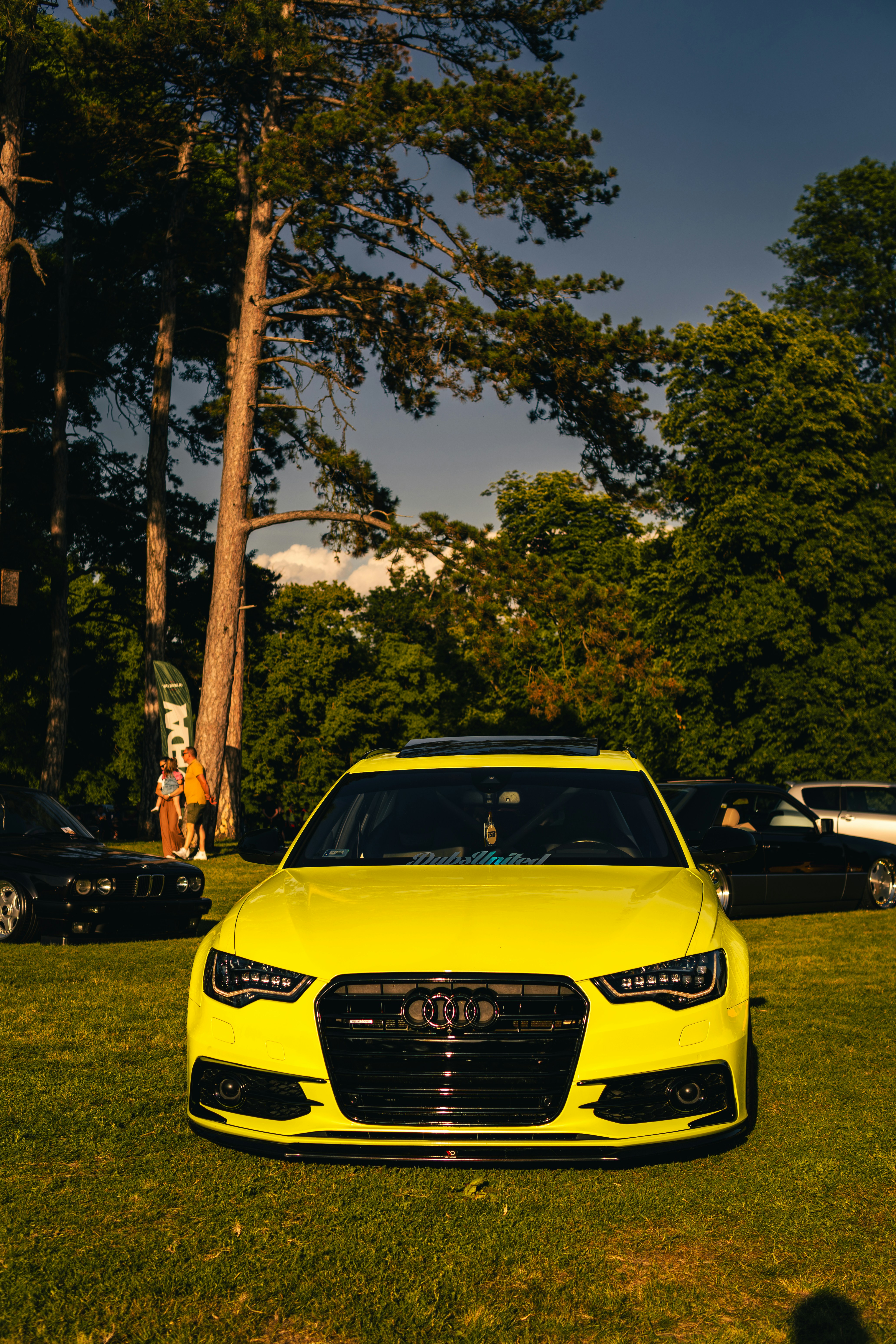 Neon-yellow Audi anchored on a sunlit field