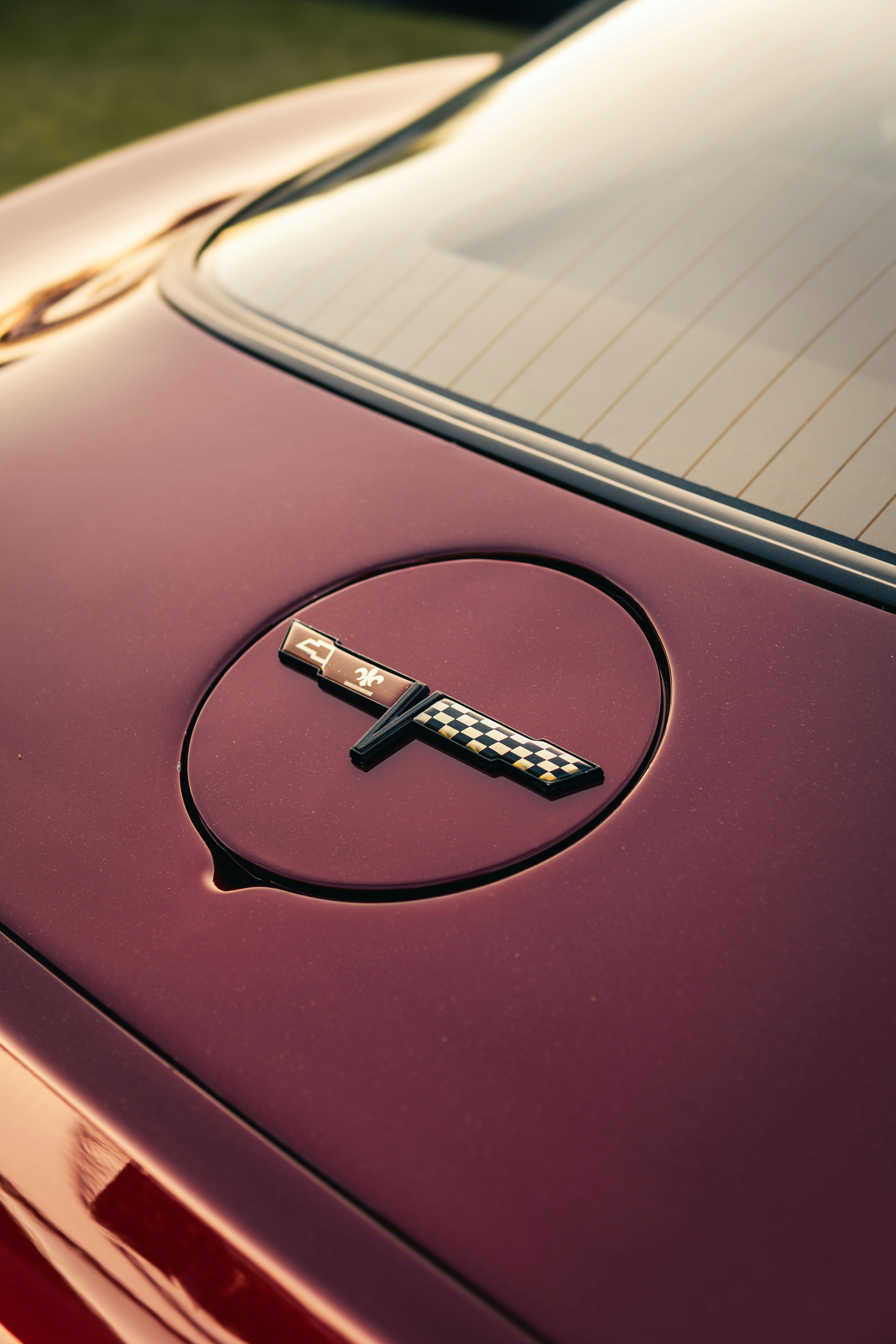 Crimson Crest on a Sunset-Gloss Corvette Hood