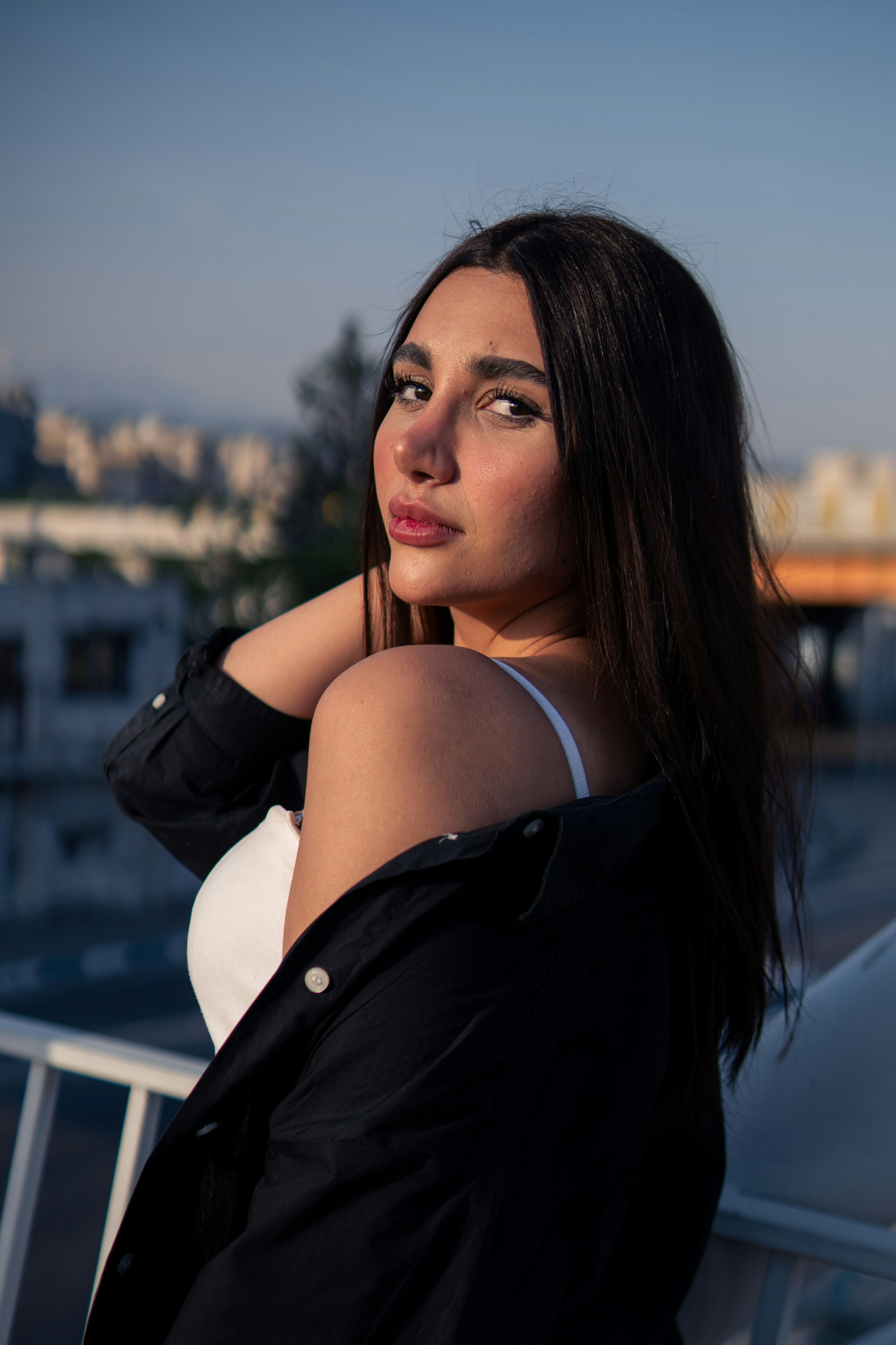 Woman looking over her shoulder outdoors