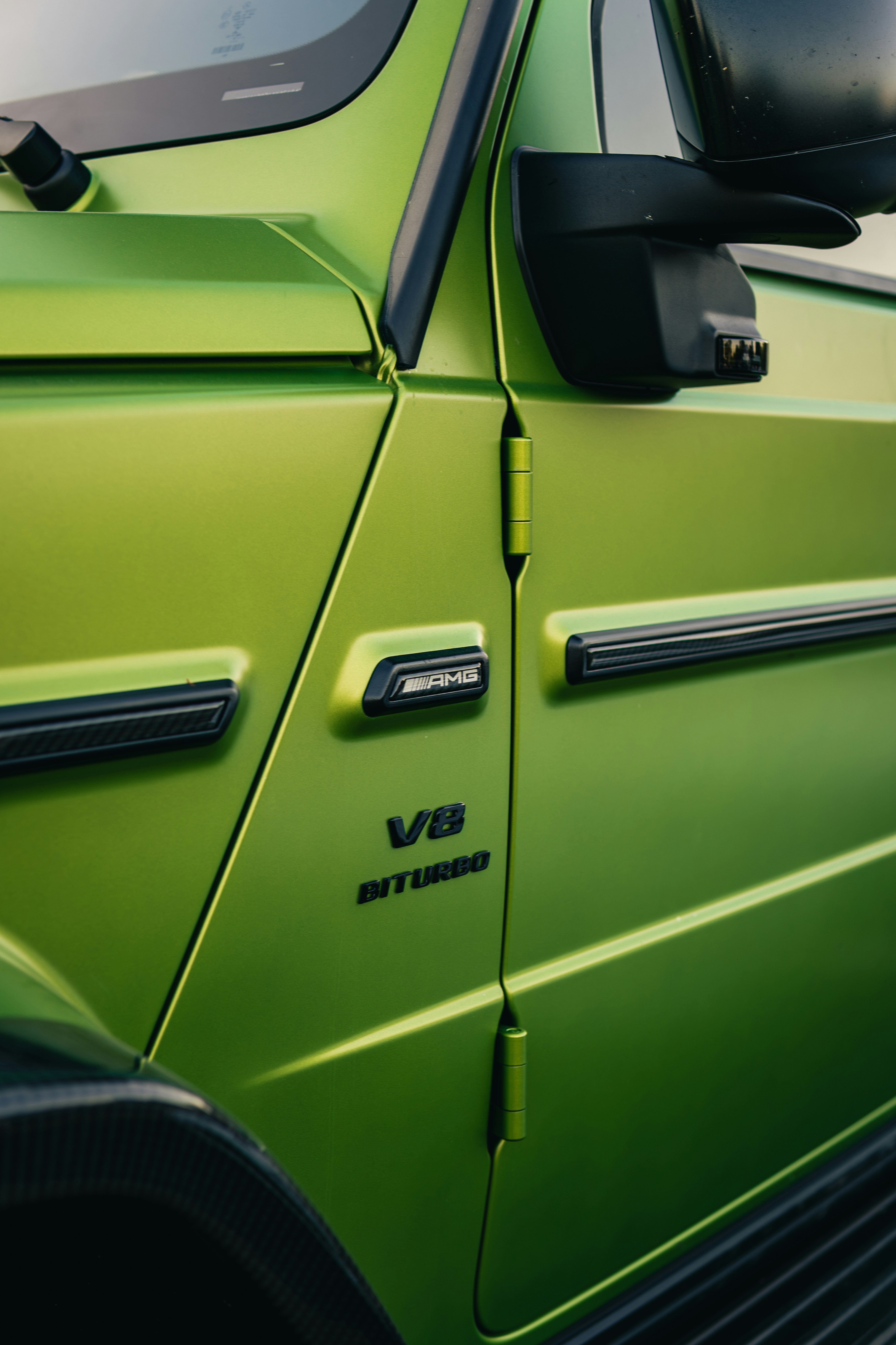 Emerald AMG Door: Close-Up on V8 Biturbo Emblem and Panel Seam