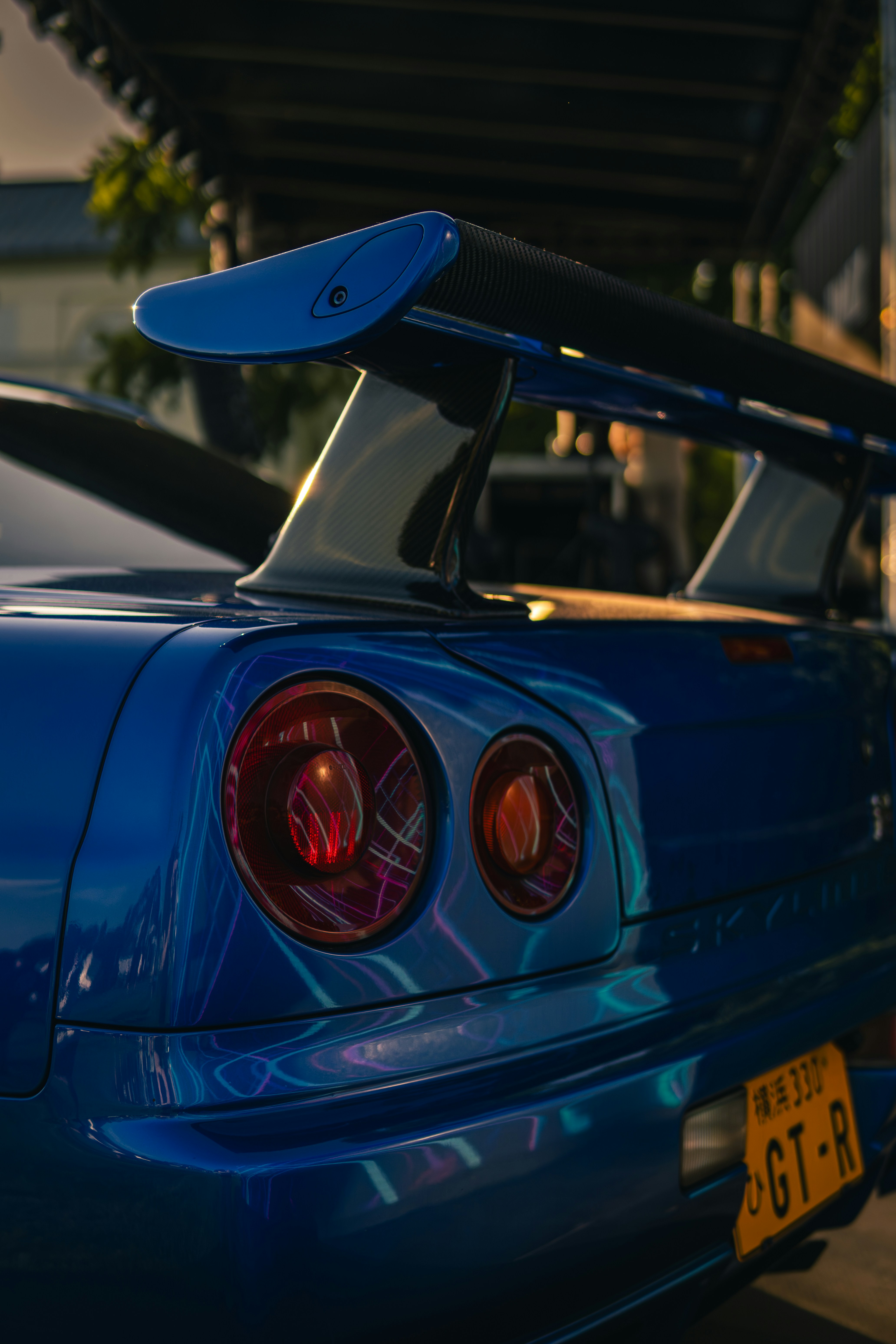 Blue sports car rear detail with spoiler