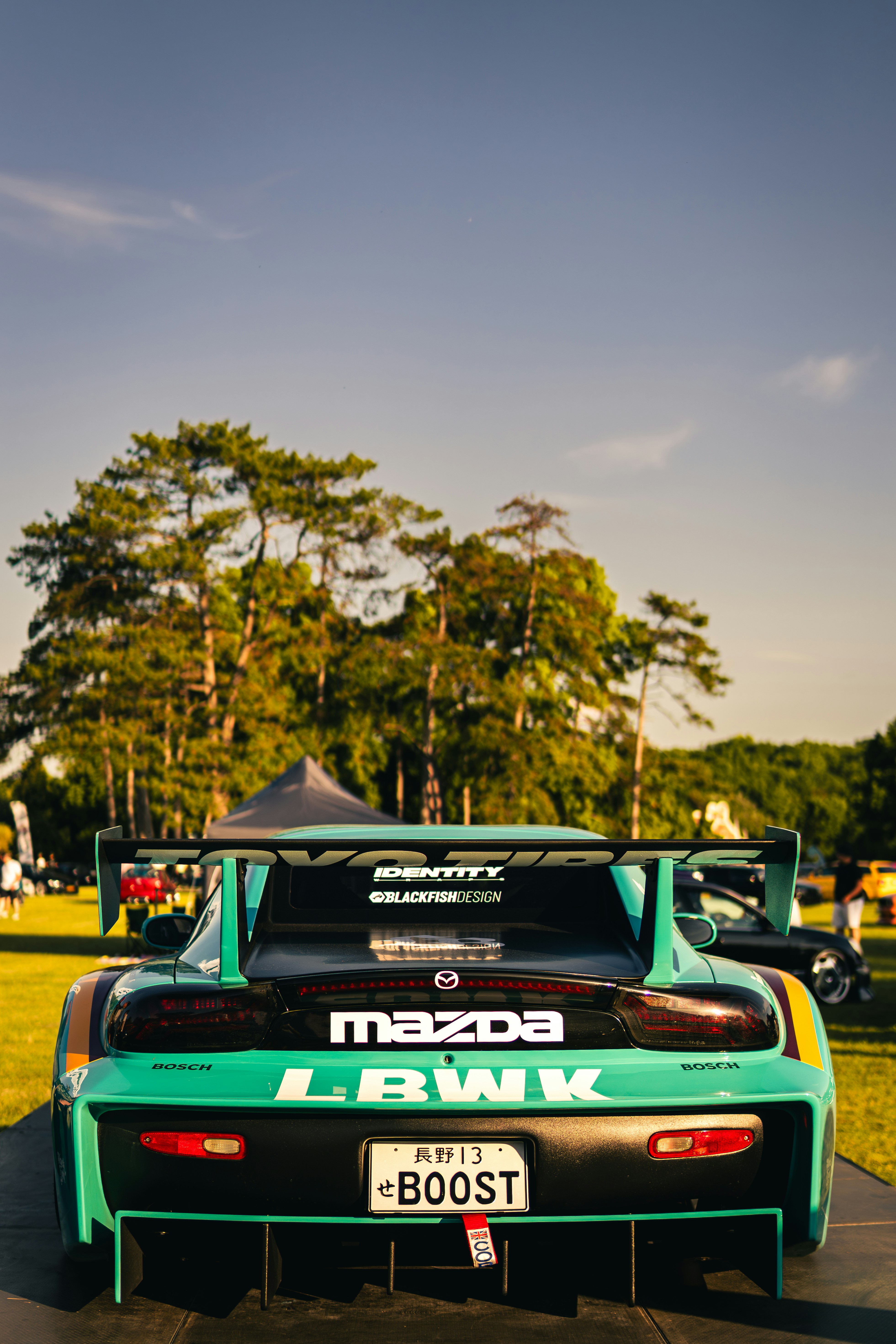Rear-Deck Precision: Teal Mazda LBWK at a Sunlit Park Car Show