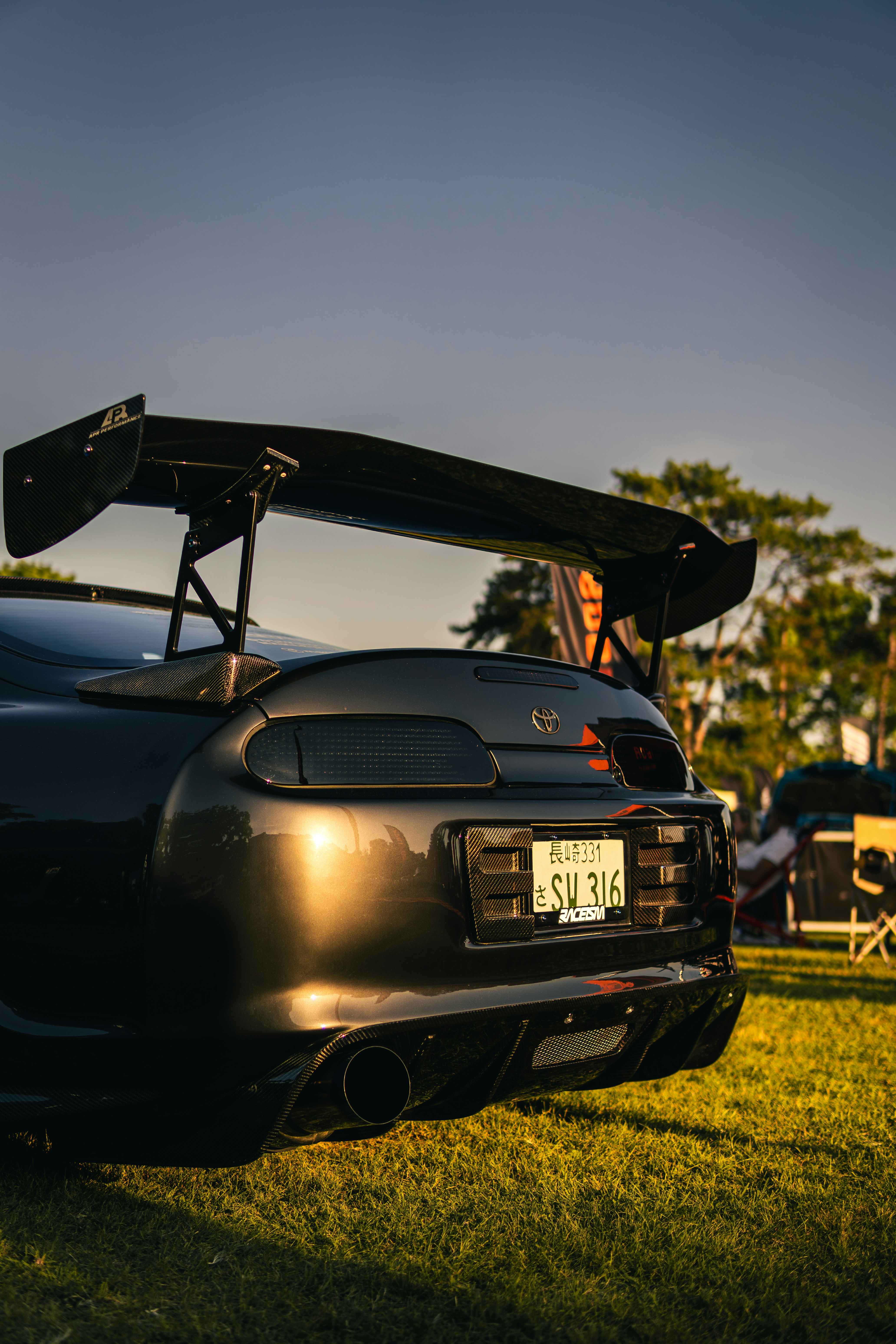 Sunset Wing: A Black Sports Car at Golden Hour