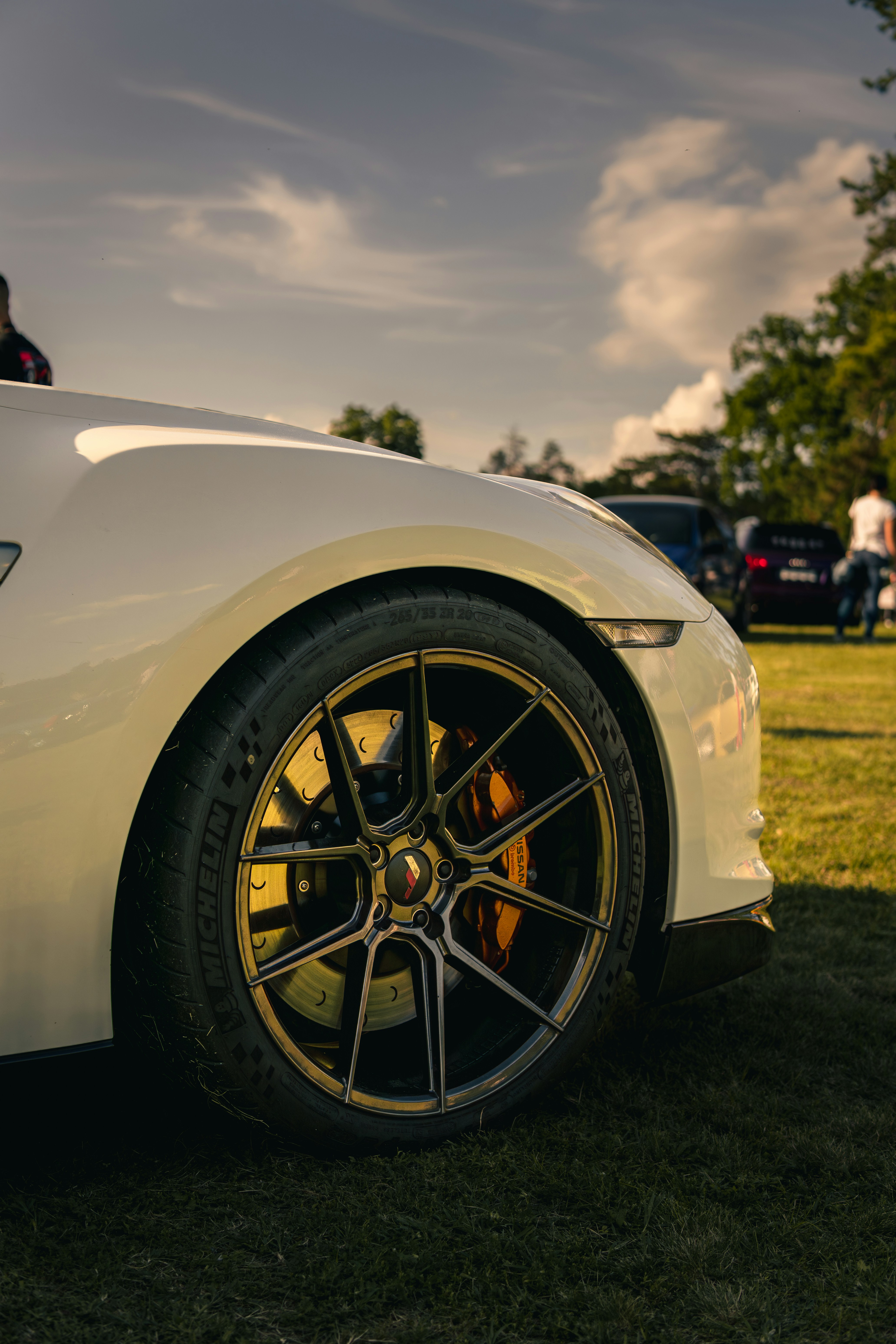 Shifting Shadows: The White Sports Car and Golden Brake Calipers