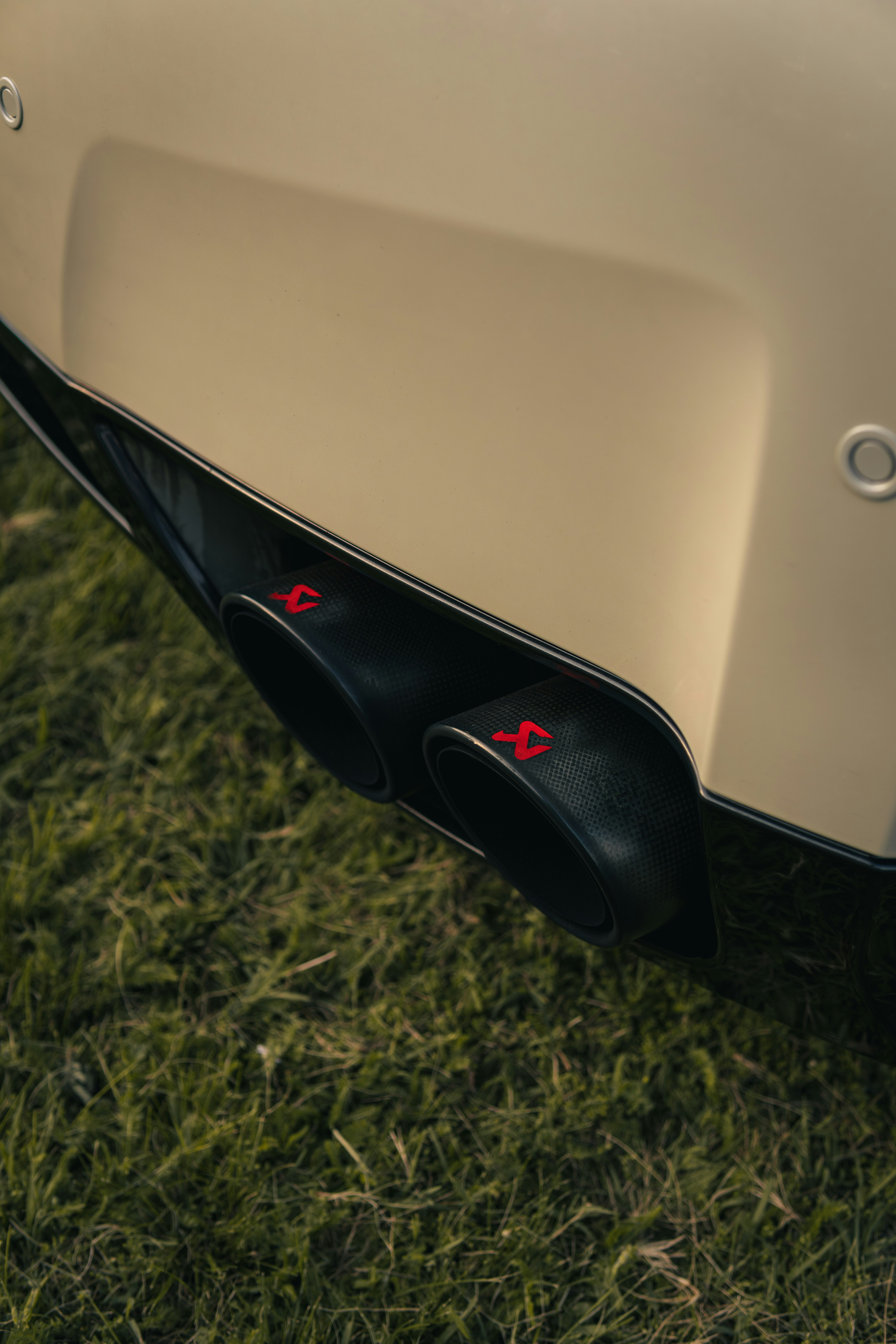 Quiet Power: Dual Exhausts Nestle Under a Cream Bumper