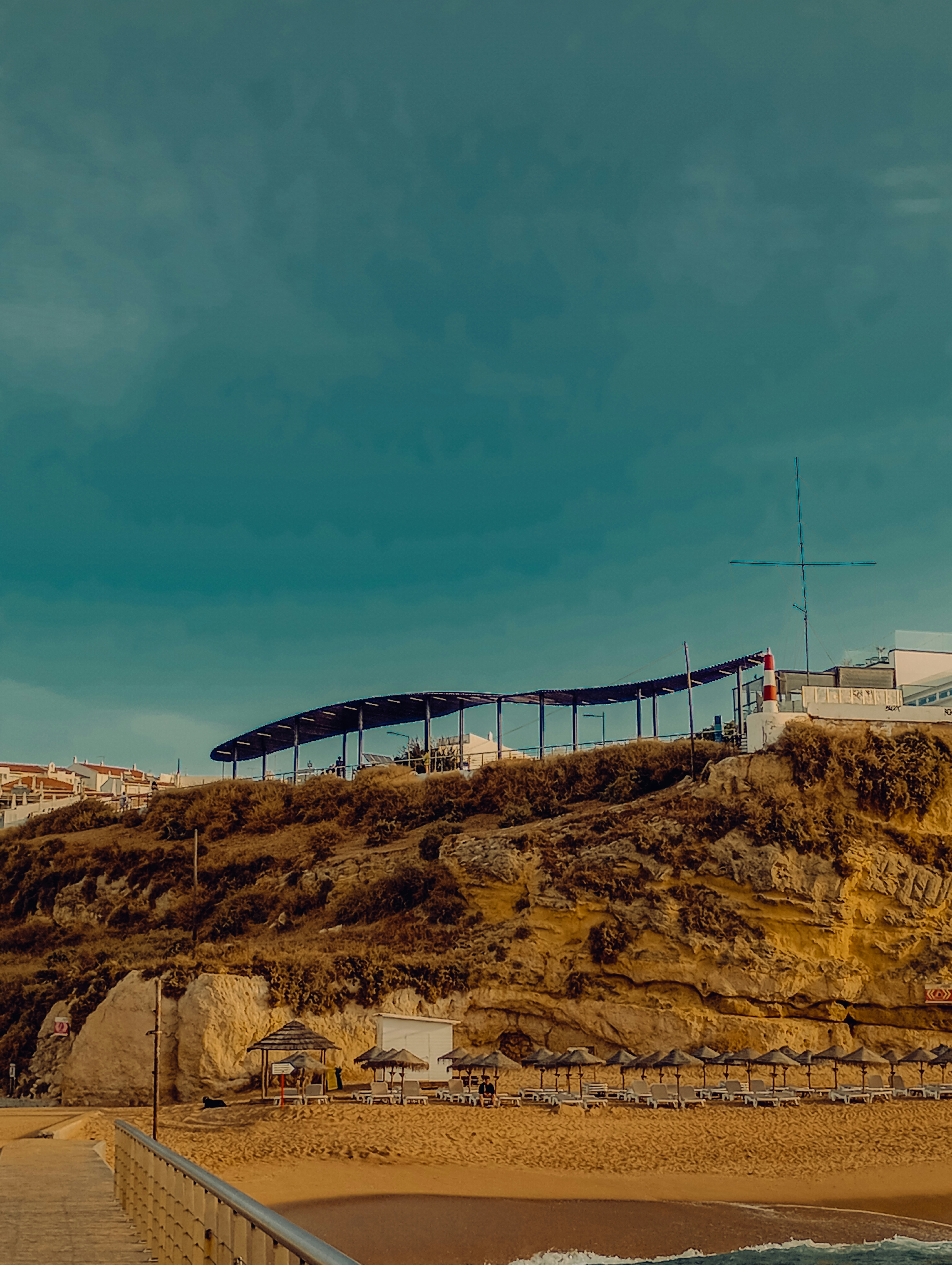 Coastal building on a hill overlooking a beach