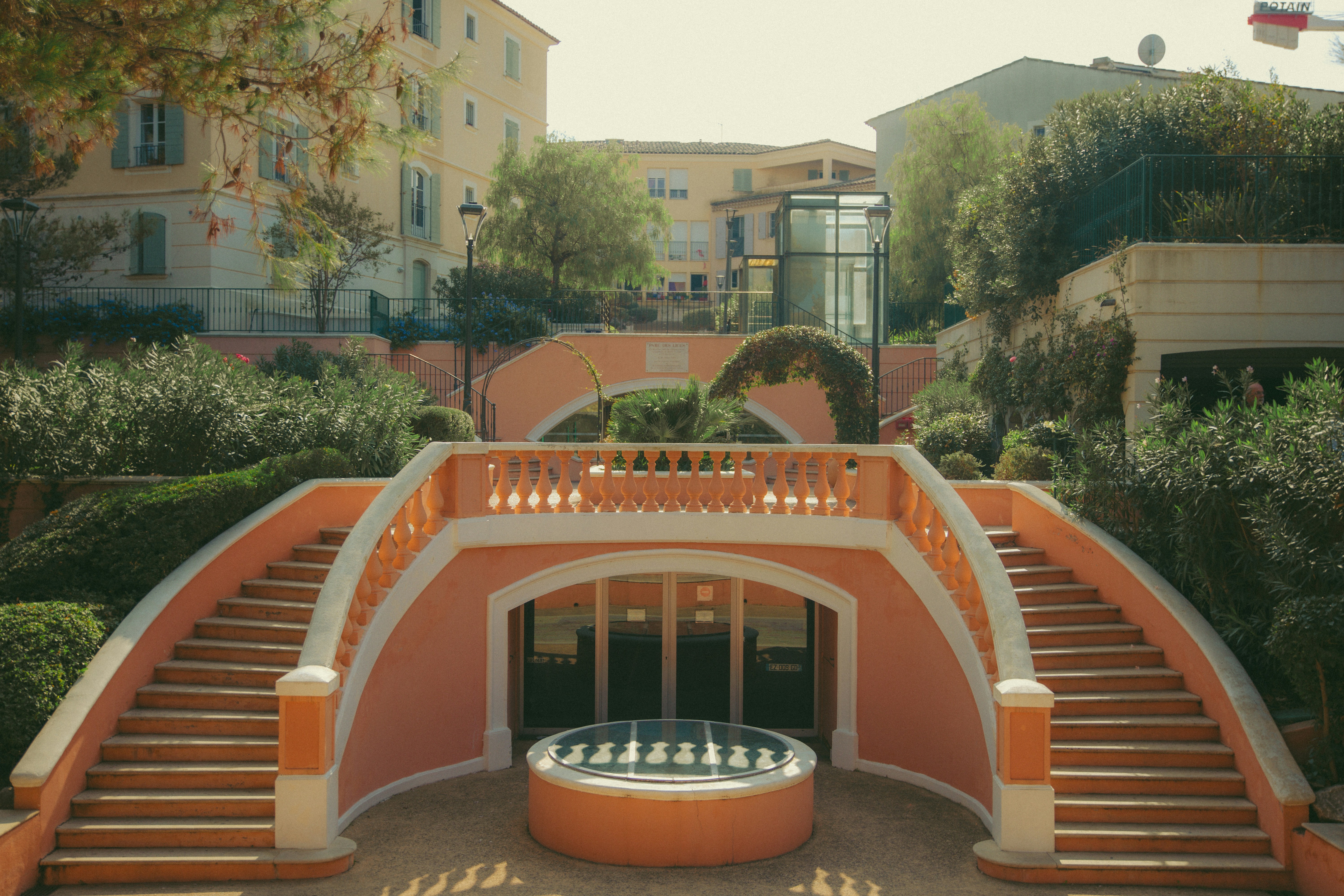 Terracotta Steps Framing a Central Fountain Under a Sunlit Arch