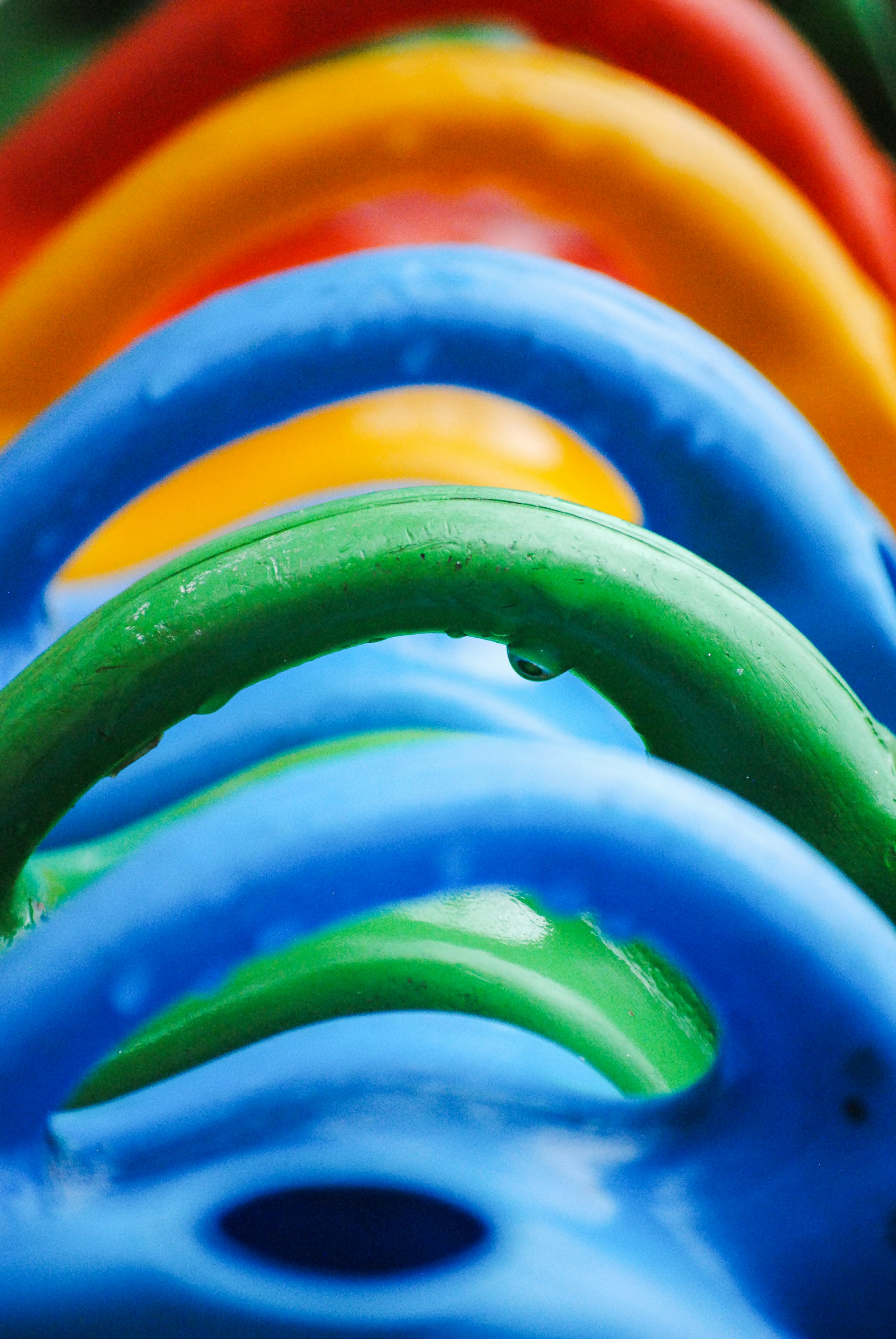 Colorful watering cans with water droplets.