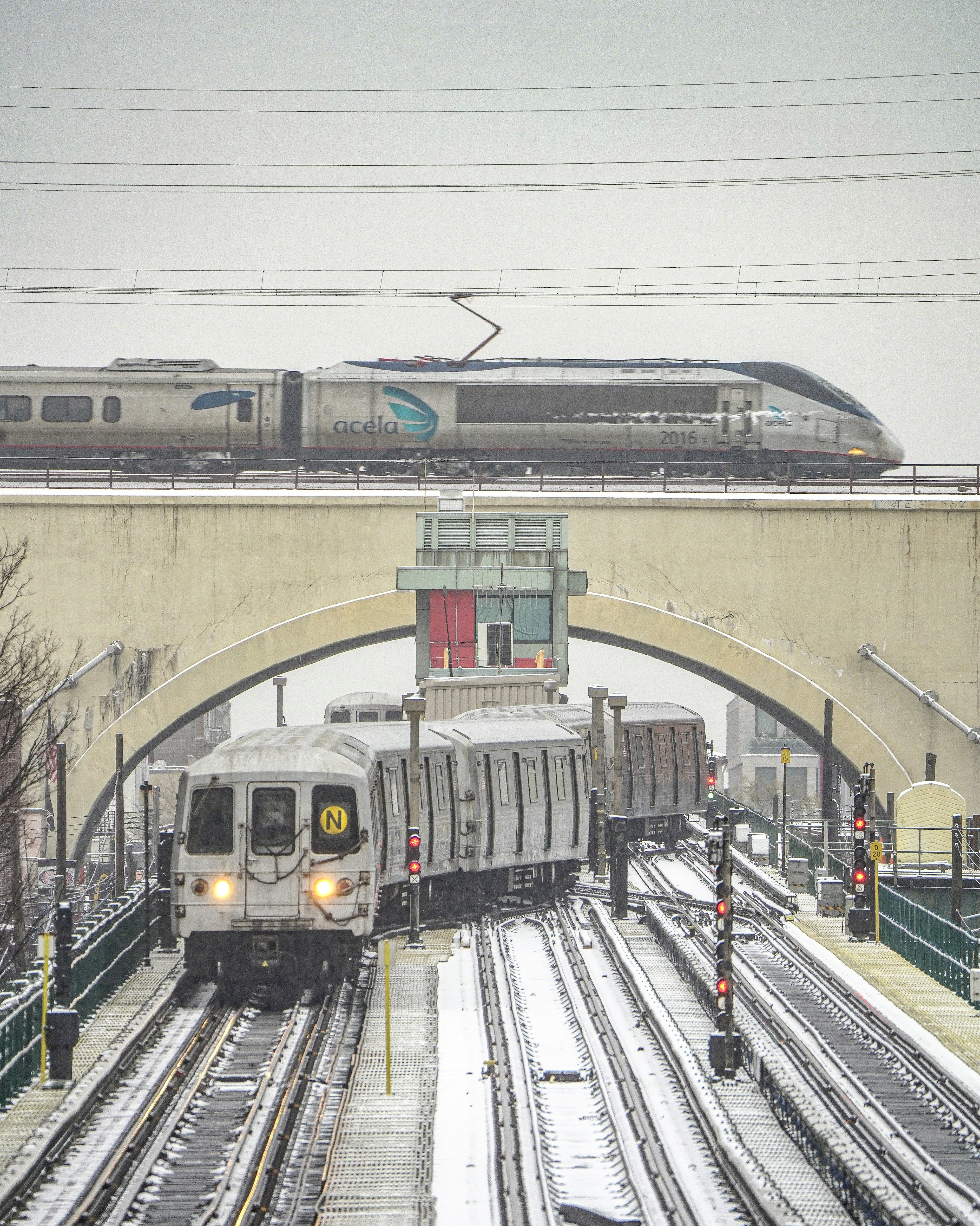 Abominable Snow Welding - SMNYCMan | Two trains on tracks under a bridge in snow.