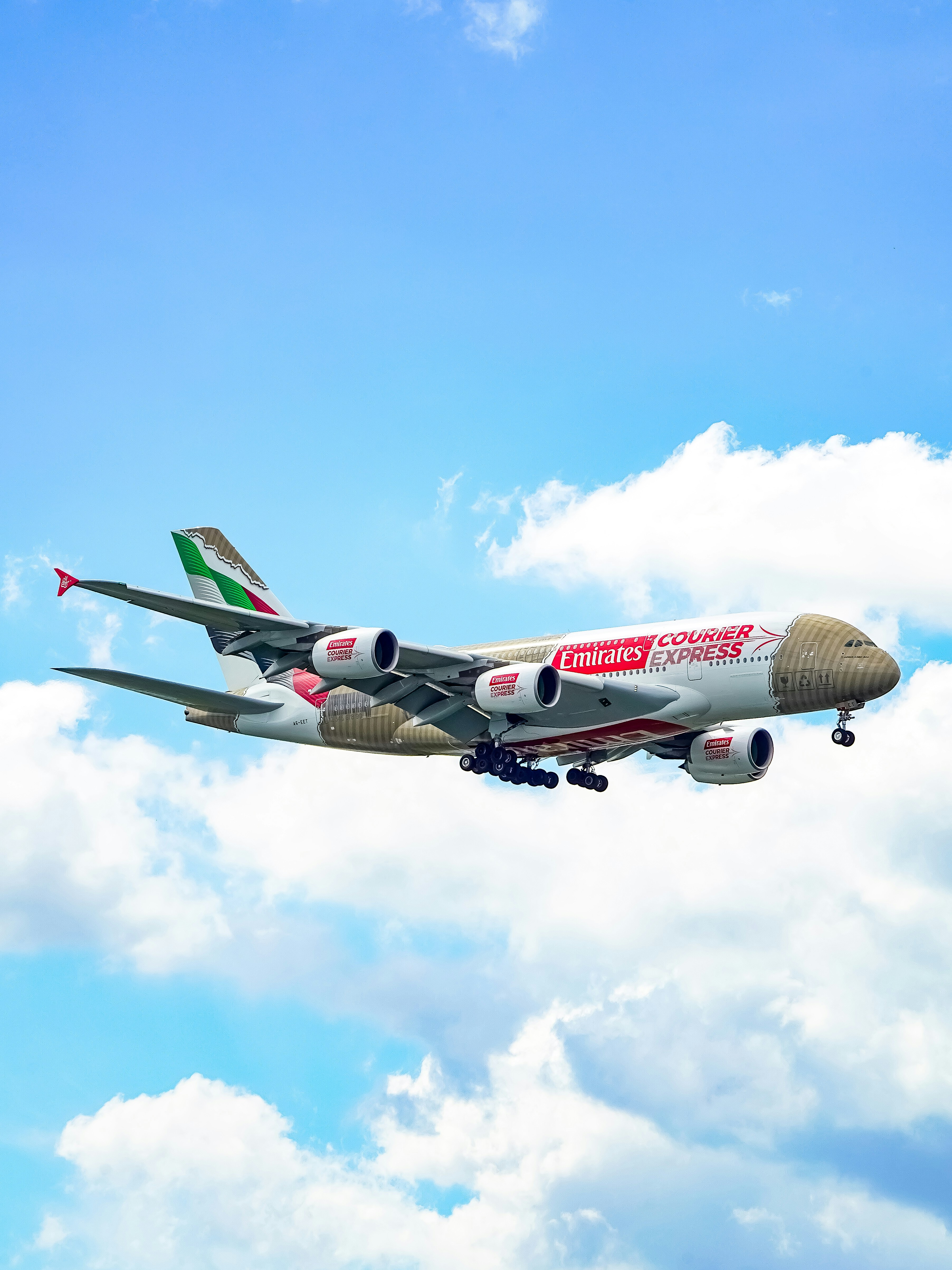 Giant Fuzzy - SMNYCMan | Emirates airplane flying in a blue sky