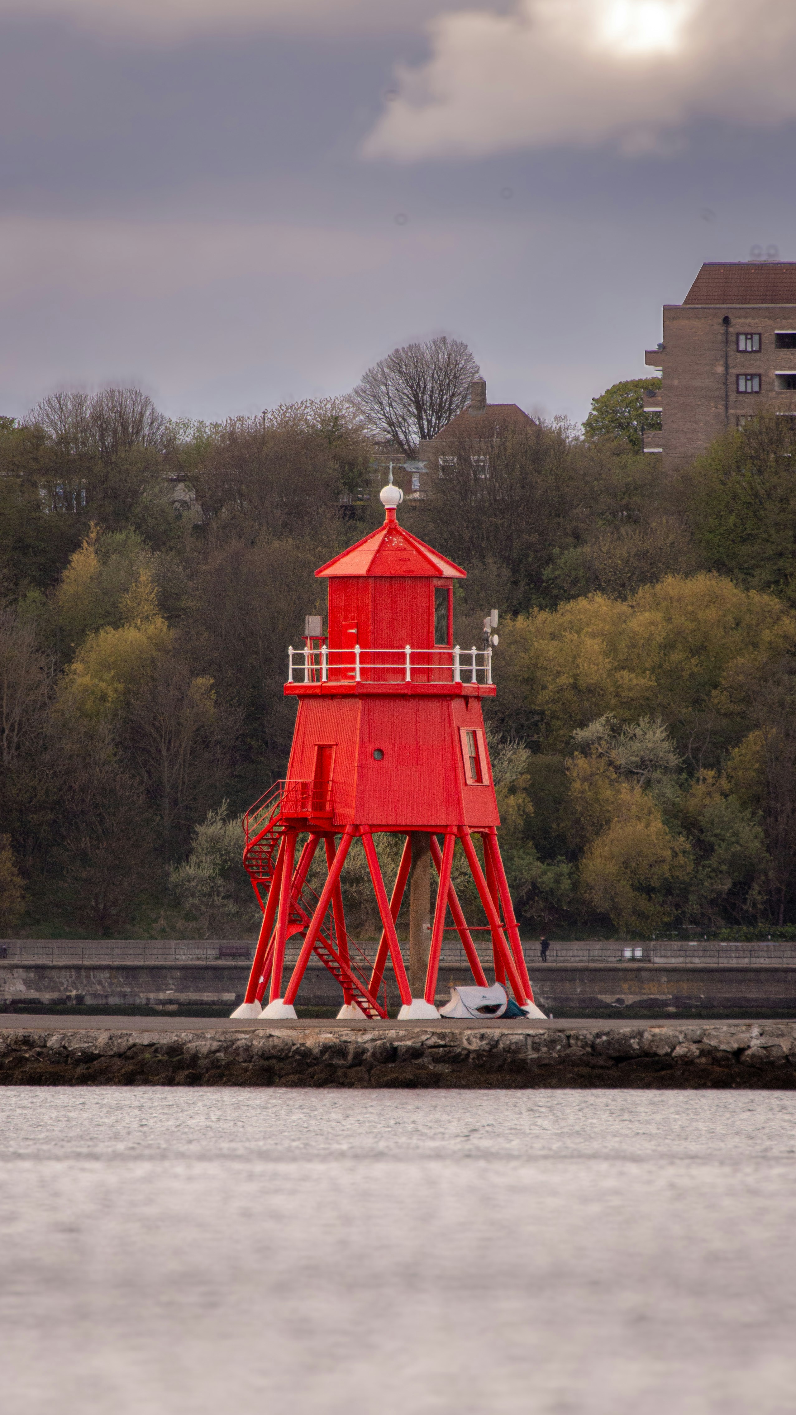 Beacon of Vibrance: The Red Lighthouse Amidst the Calm