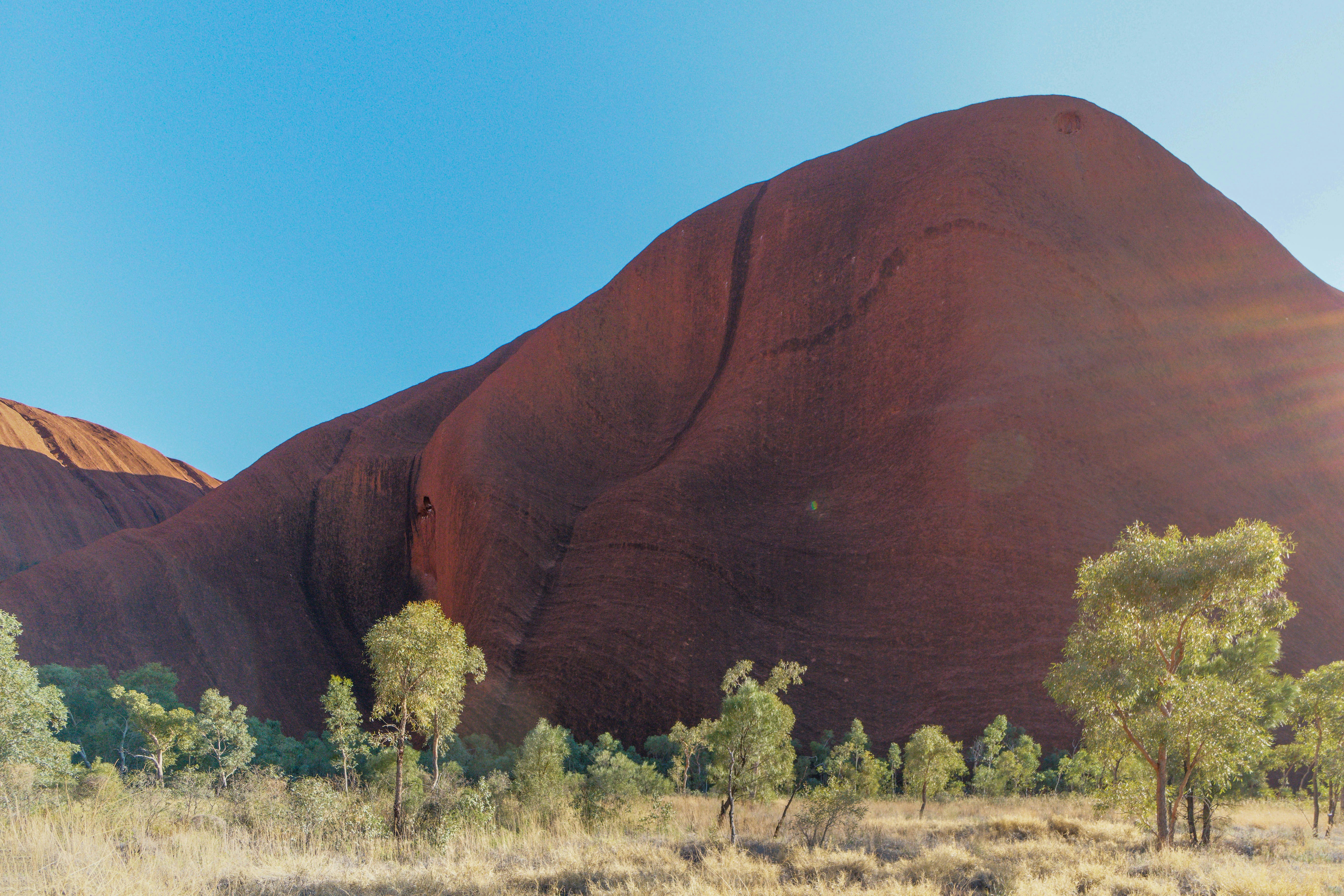 Red Monolith Beneath a Clear Sky: Desert Light on a Dome
