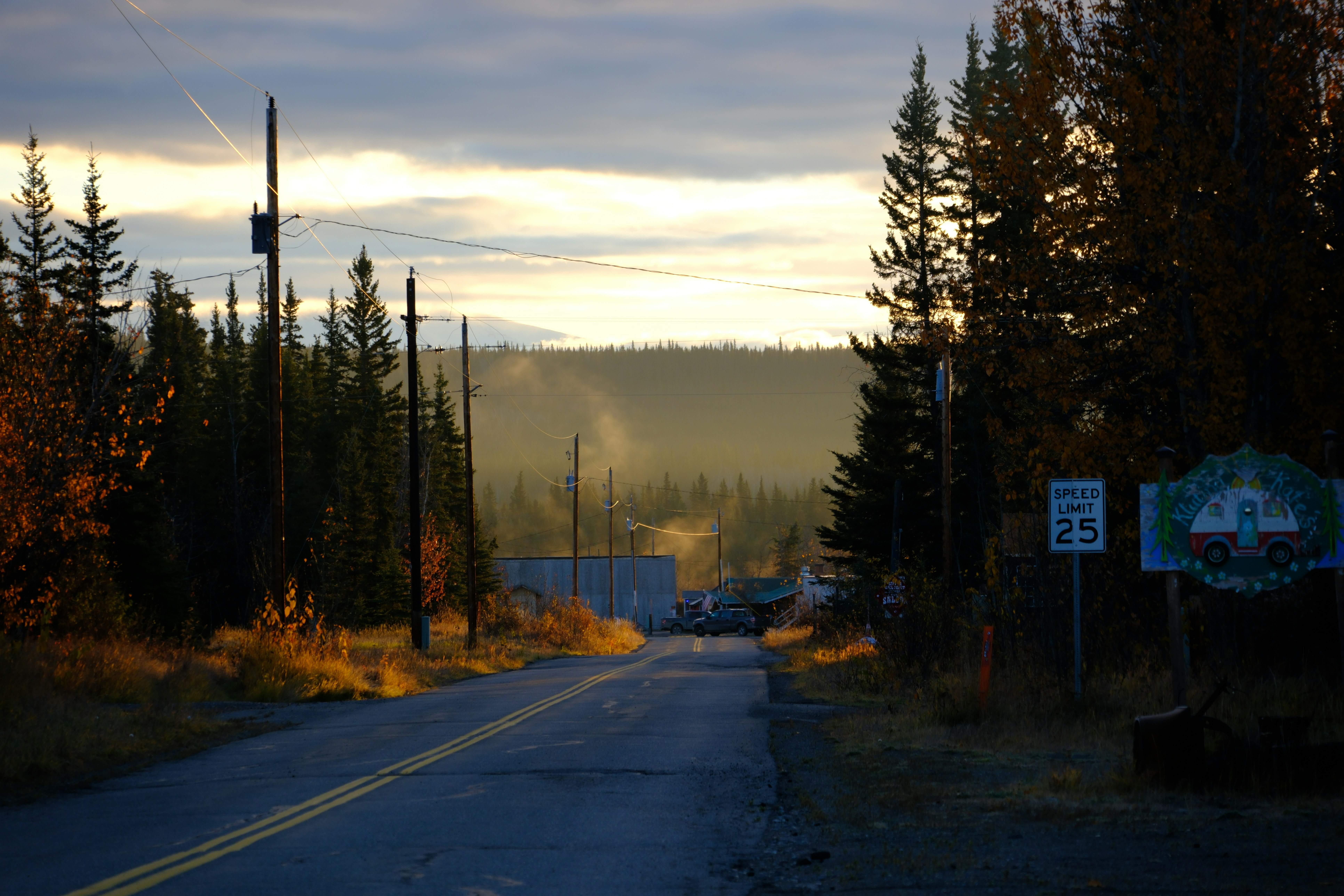 Cooper Center, Glennallen, Alaska | Road leading into a rural town at sunset