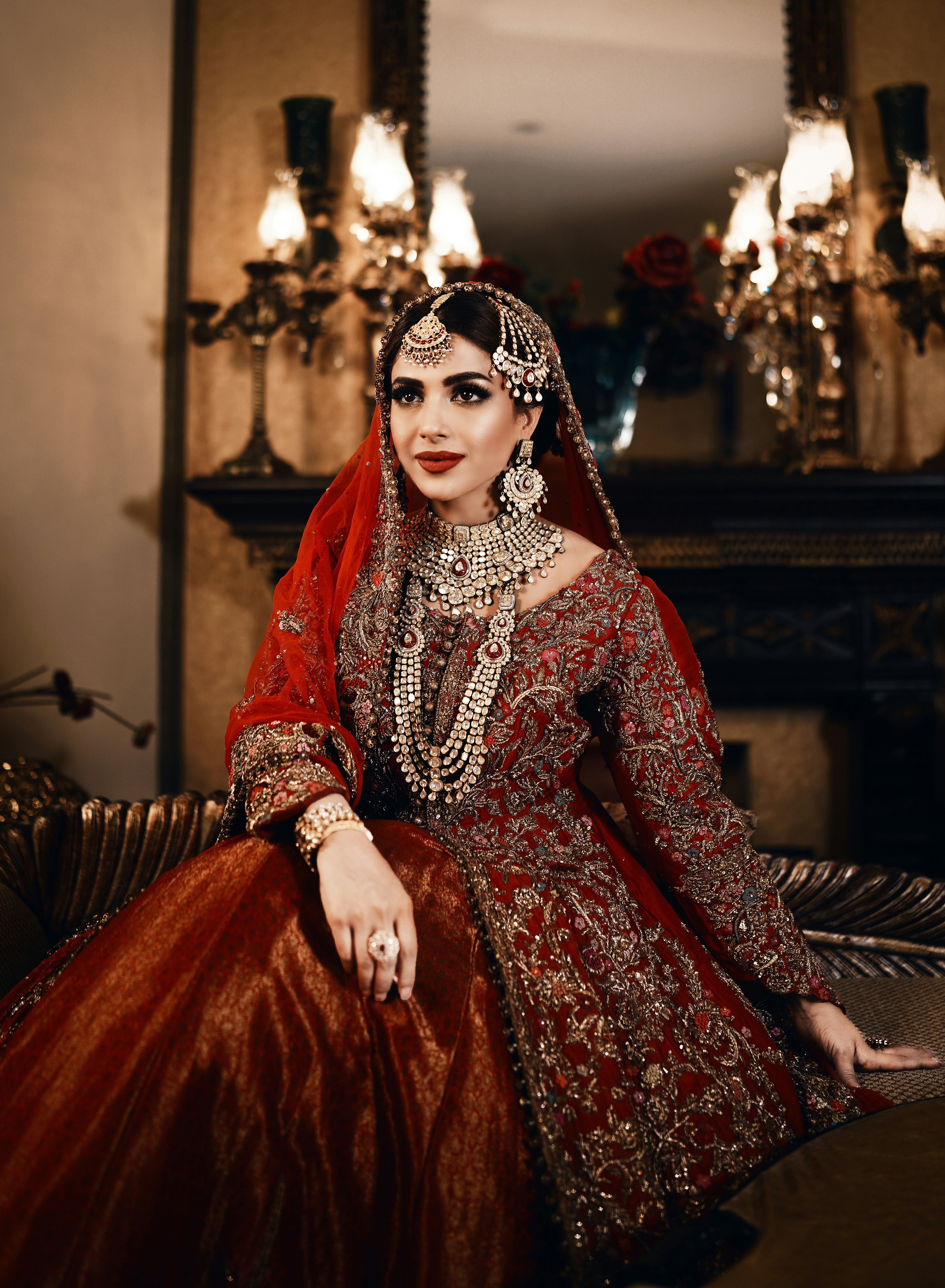 A bride in ornate red and gold attire