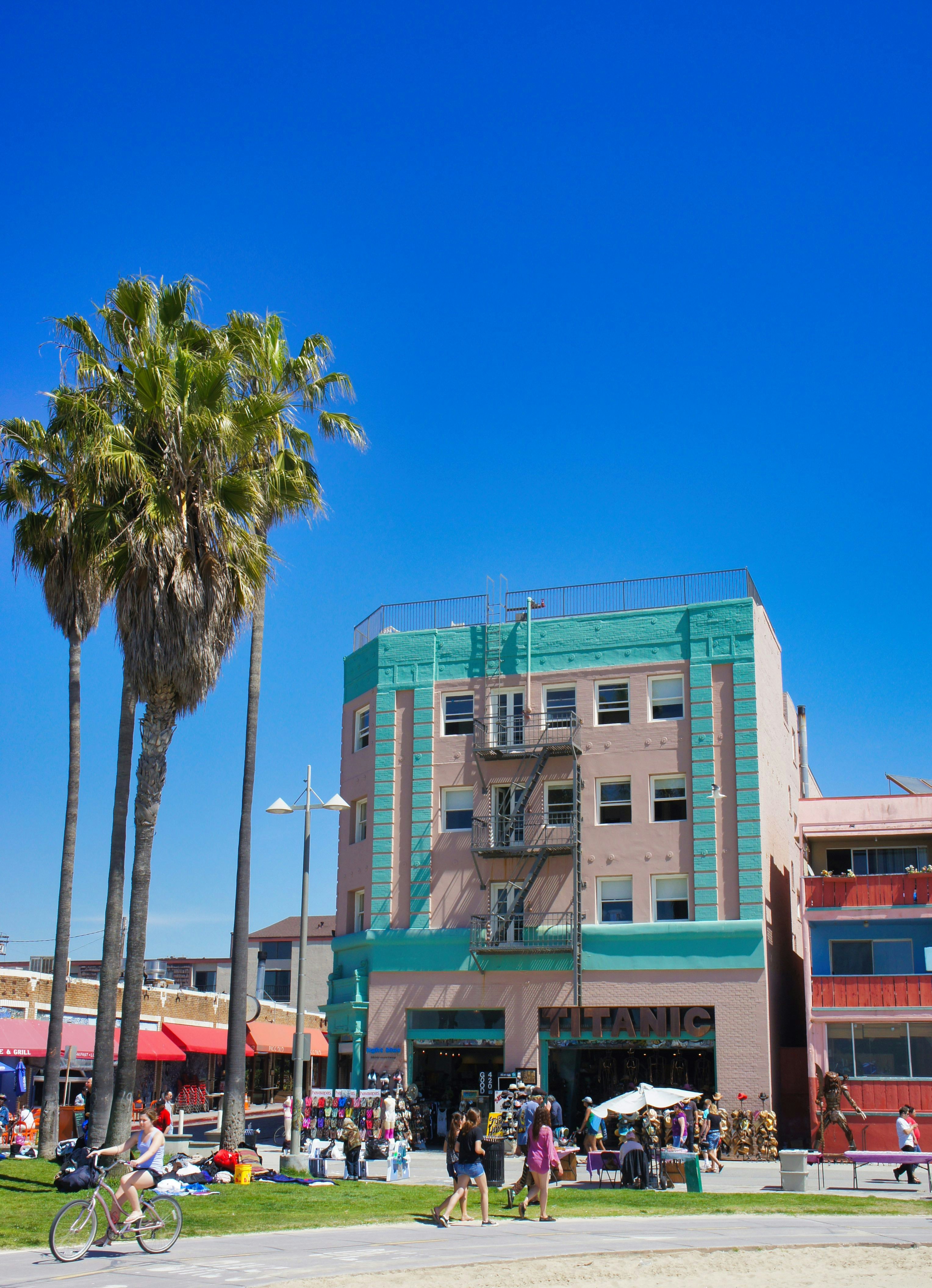 People enjoying a sunny day near beach buildings