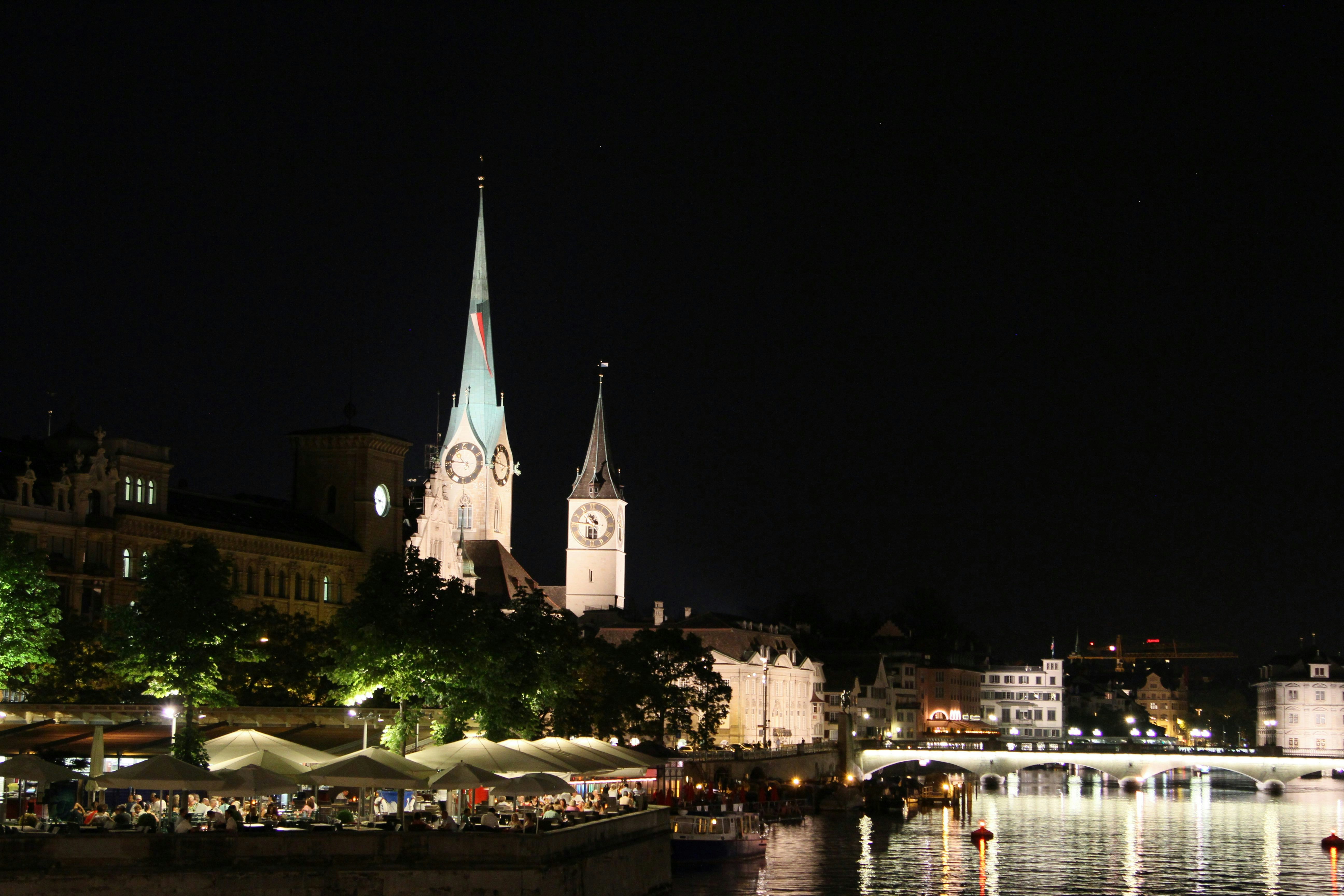 City skyline with illuminated church towers at night.