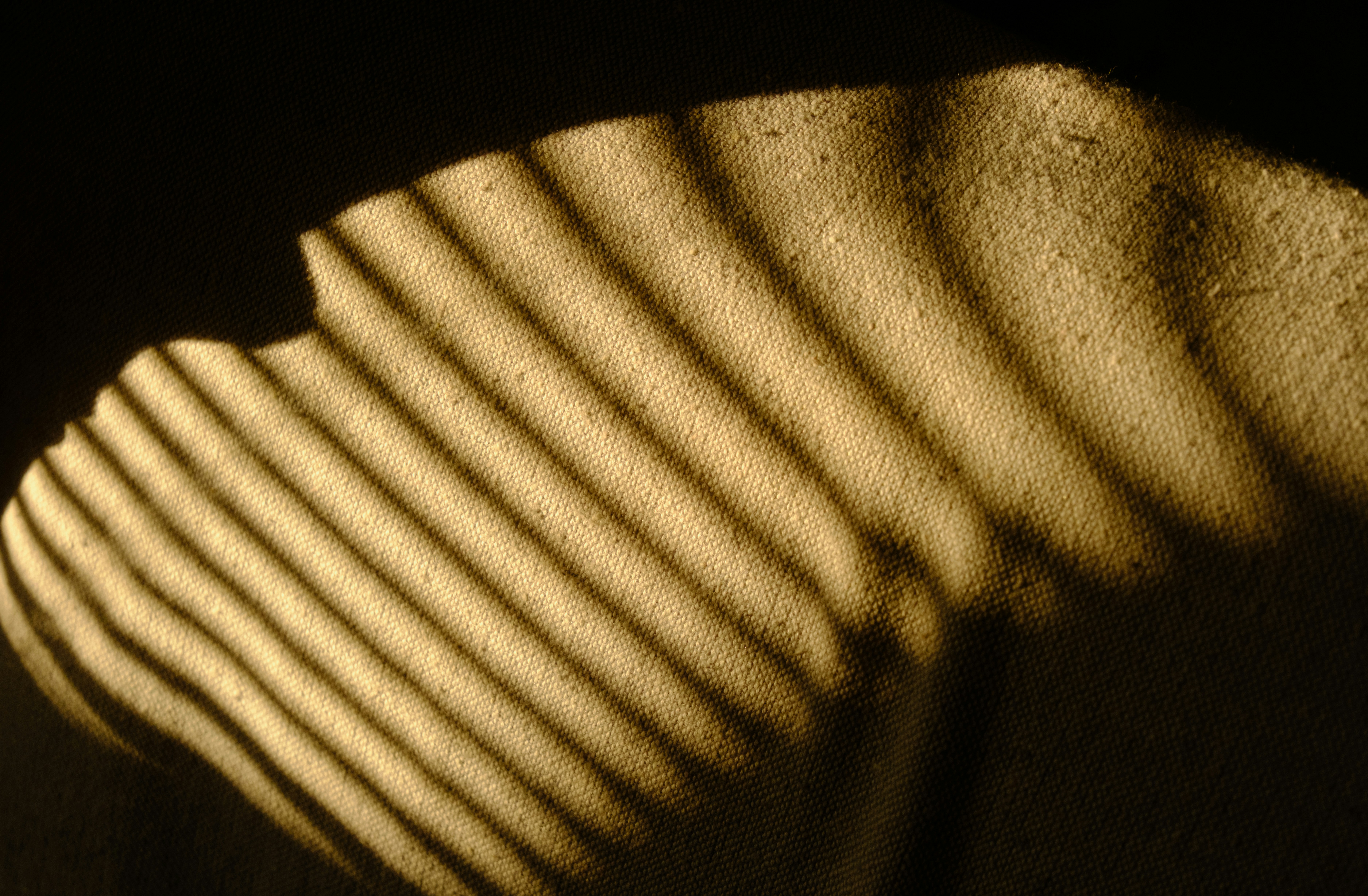 Afternoon light on fabric | Shadows cast by blinds on a textured surface