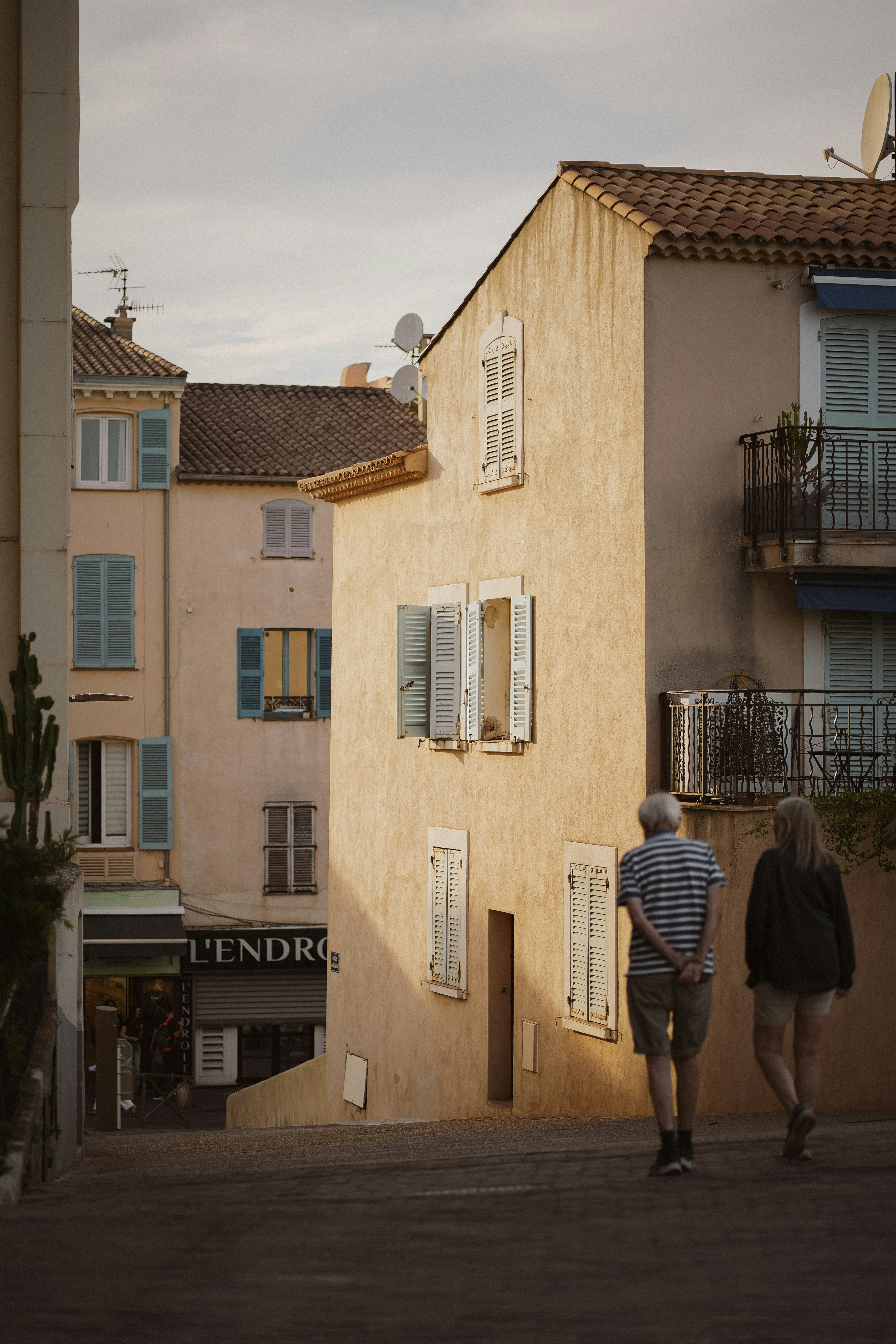 Couple walking up a sunlit european street