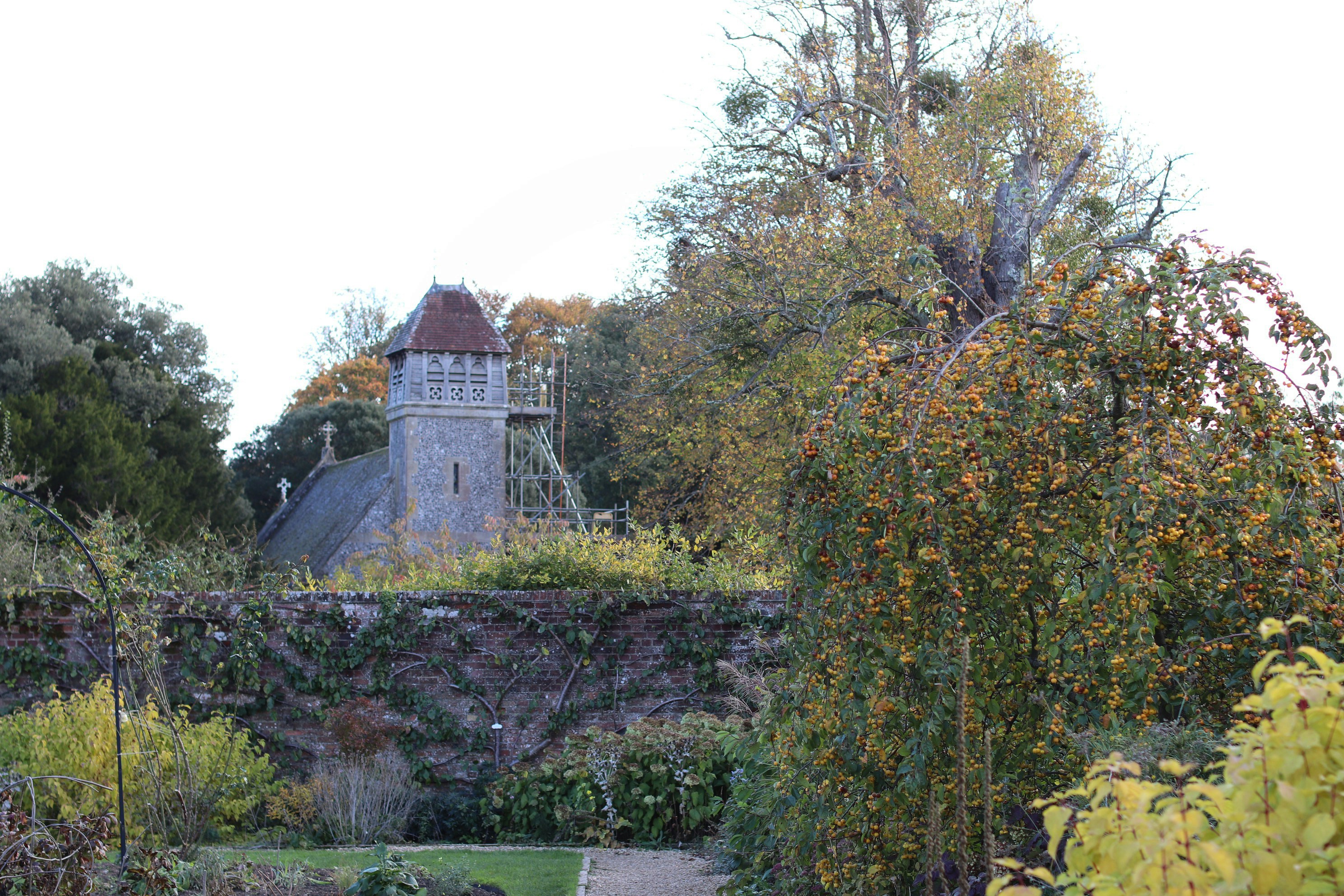 Stone tower and garden with autumn foliage