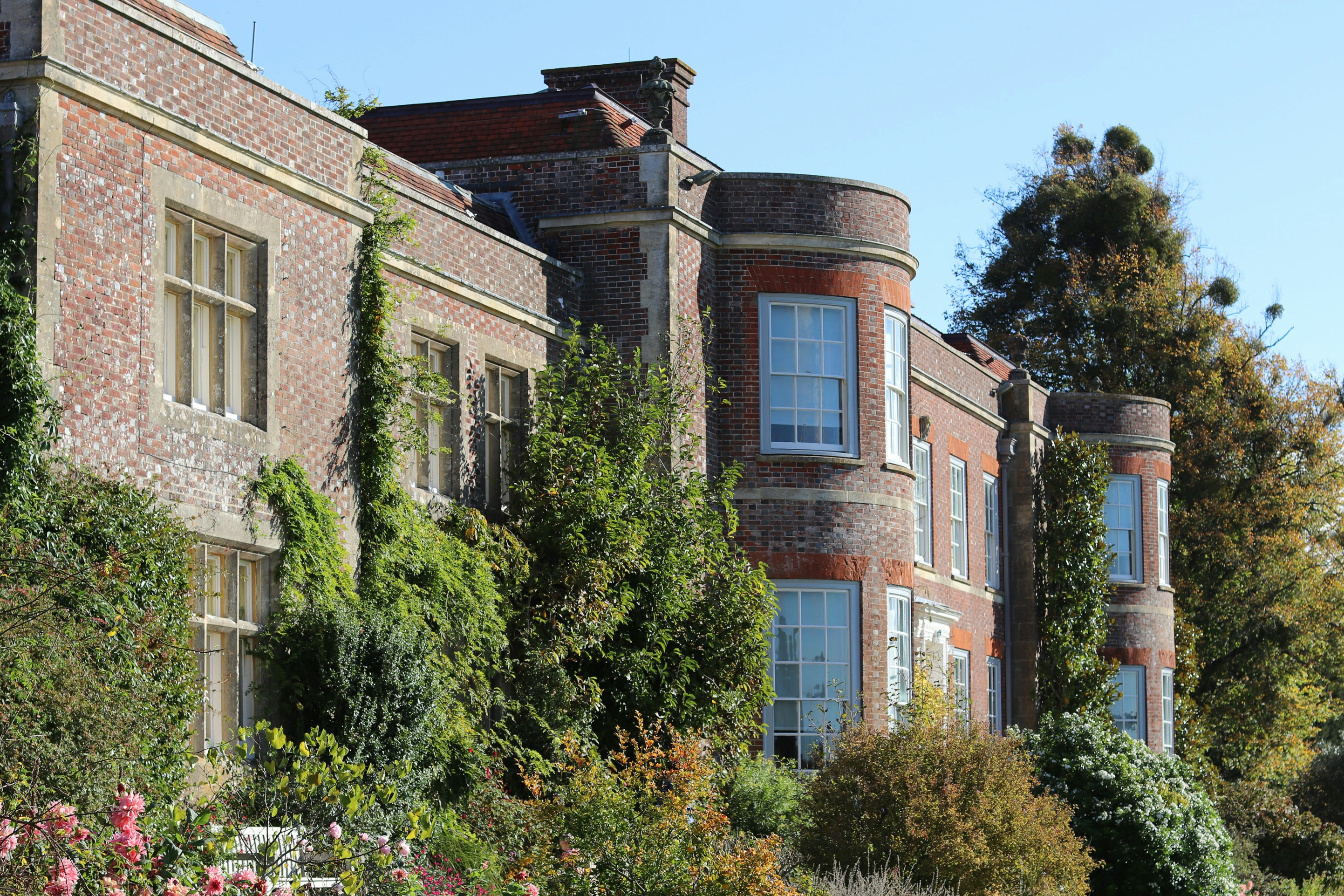 A historic brick manor house with lush gardens