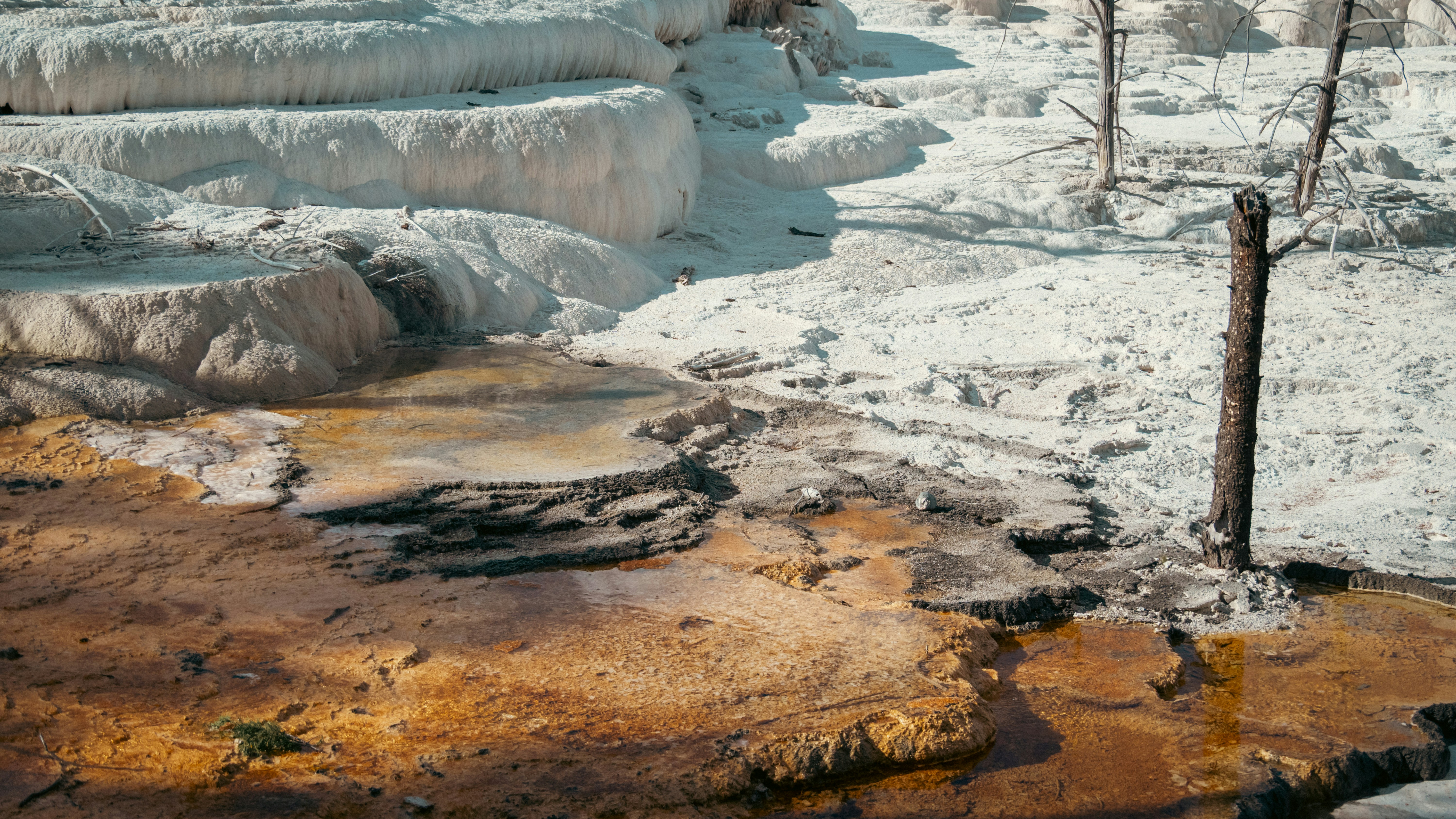 Mineral deposits and water flow in a natural landscape.