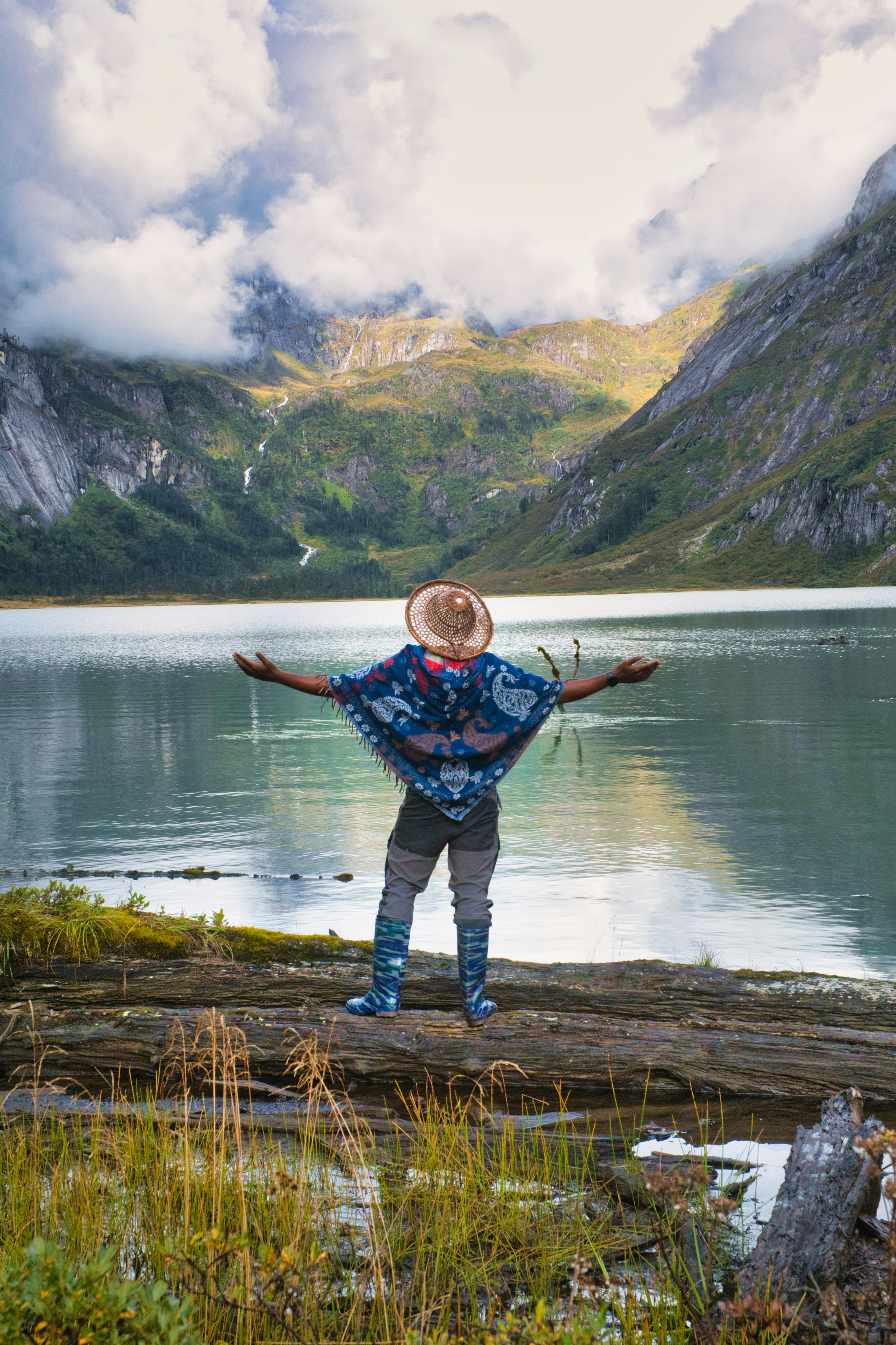 Open-Arms Reverie by a Glassy Alpine Lake