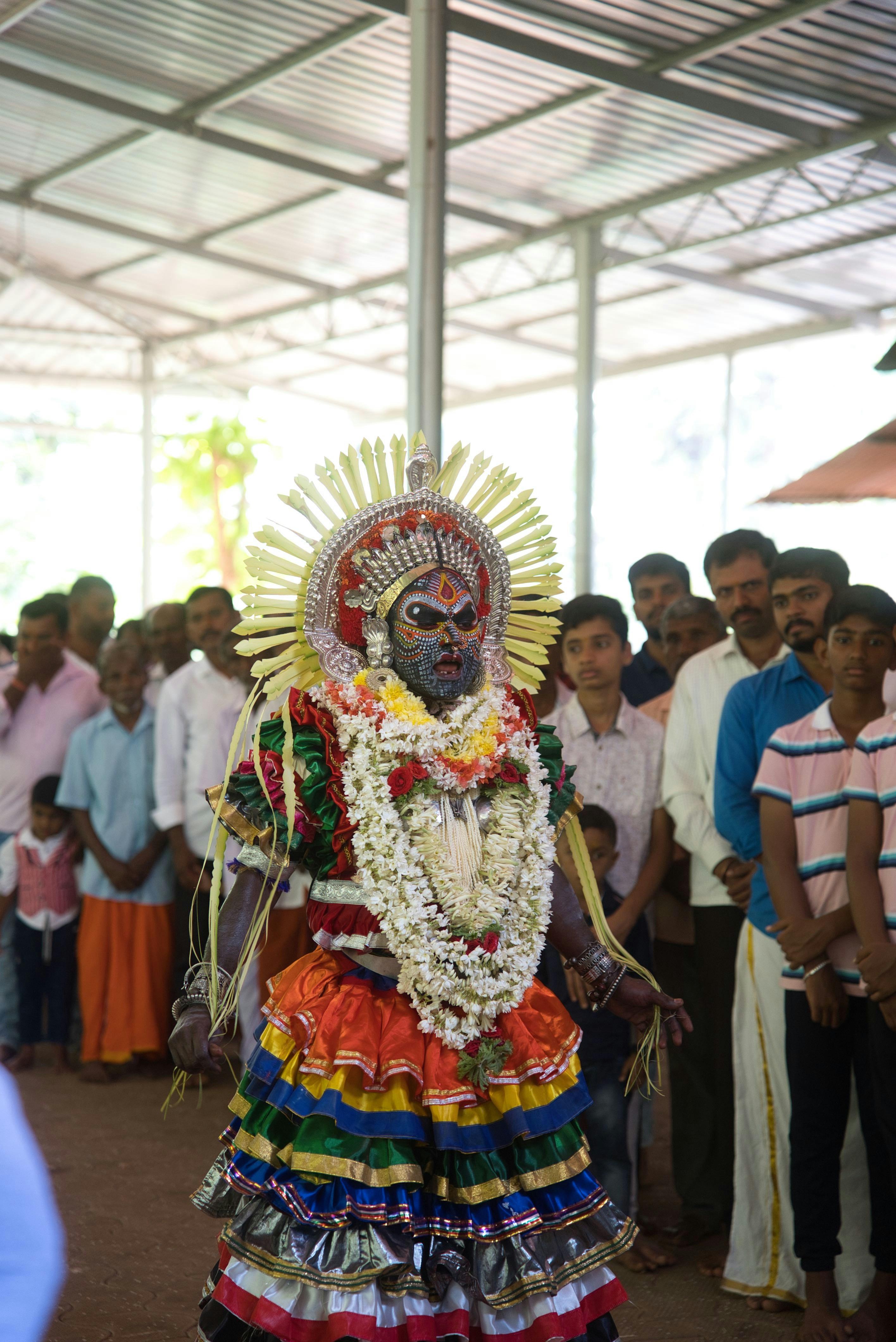 Man in elaborate costume and headdress performing