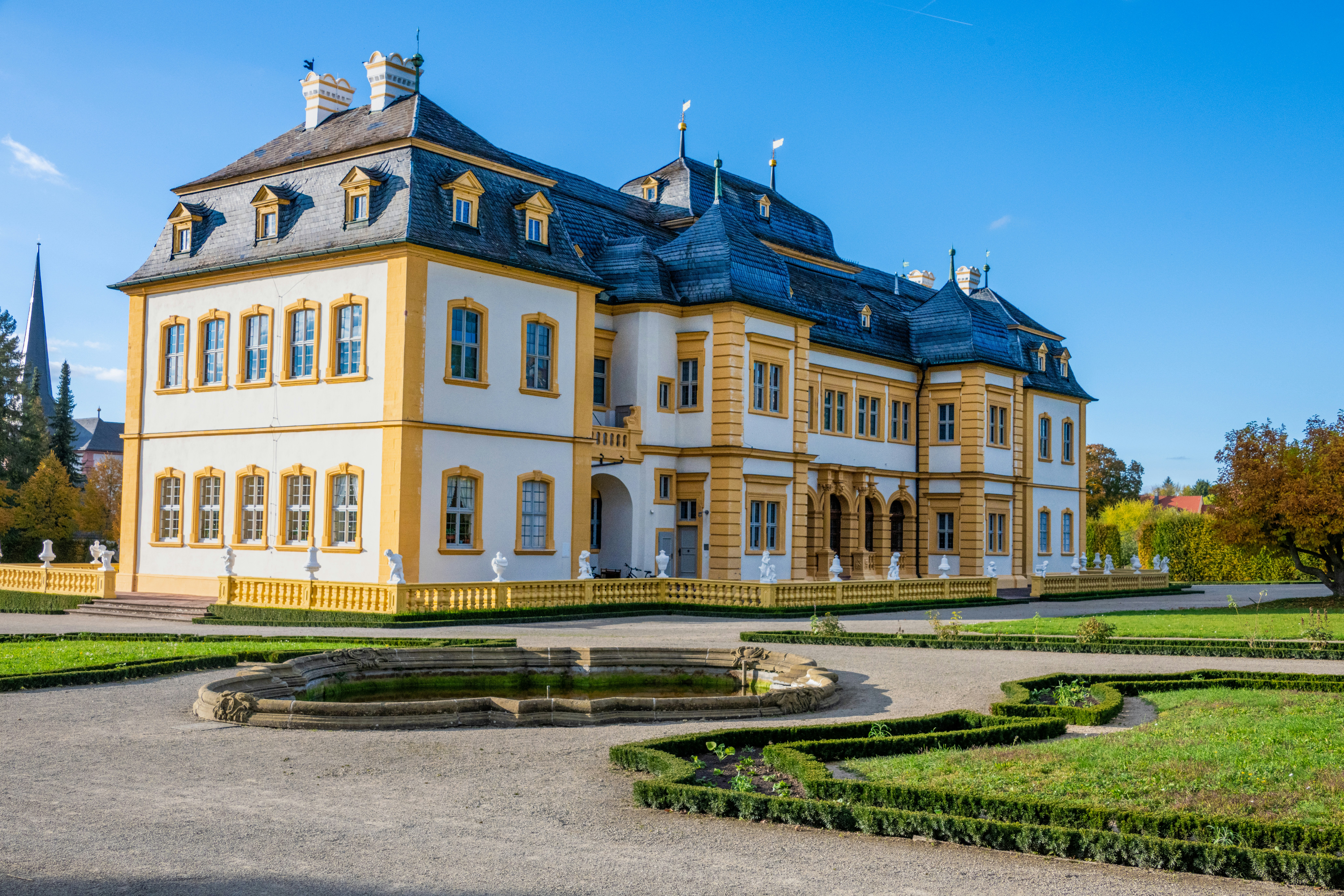 A grand baroque palace with manicured gardens