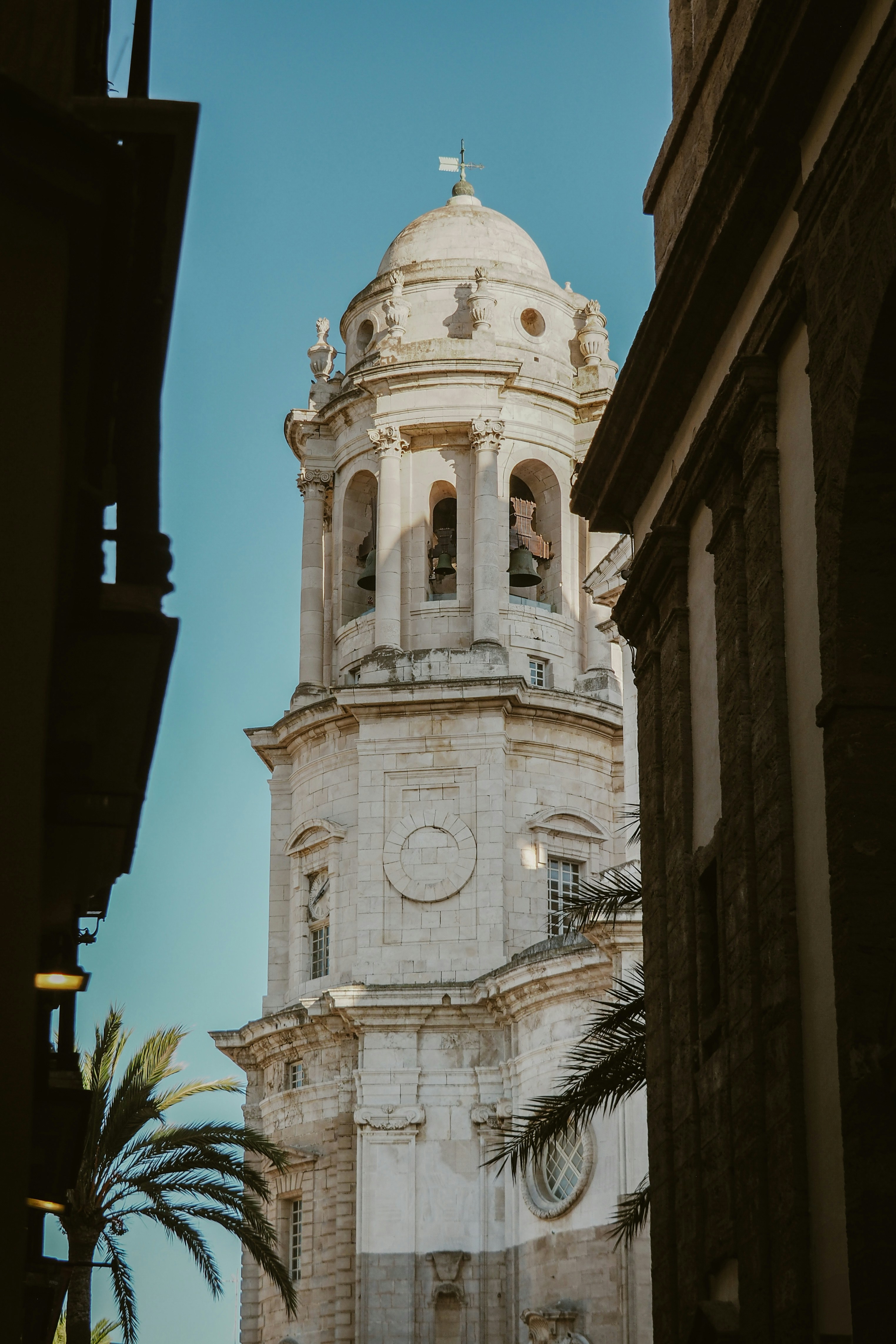Church bells are ringing! | Ornate bell tower of a cathedral against blue sky.
