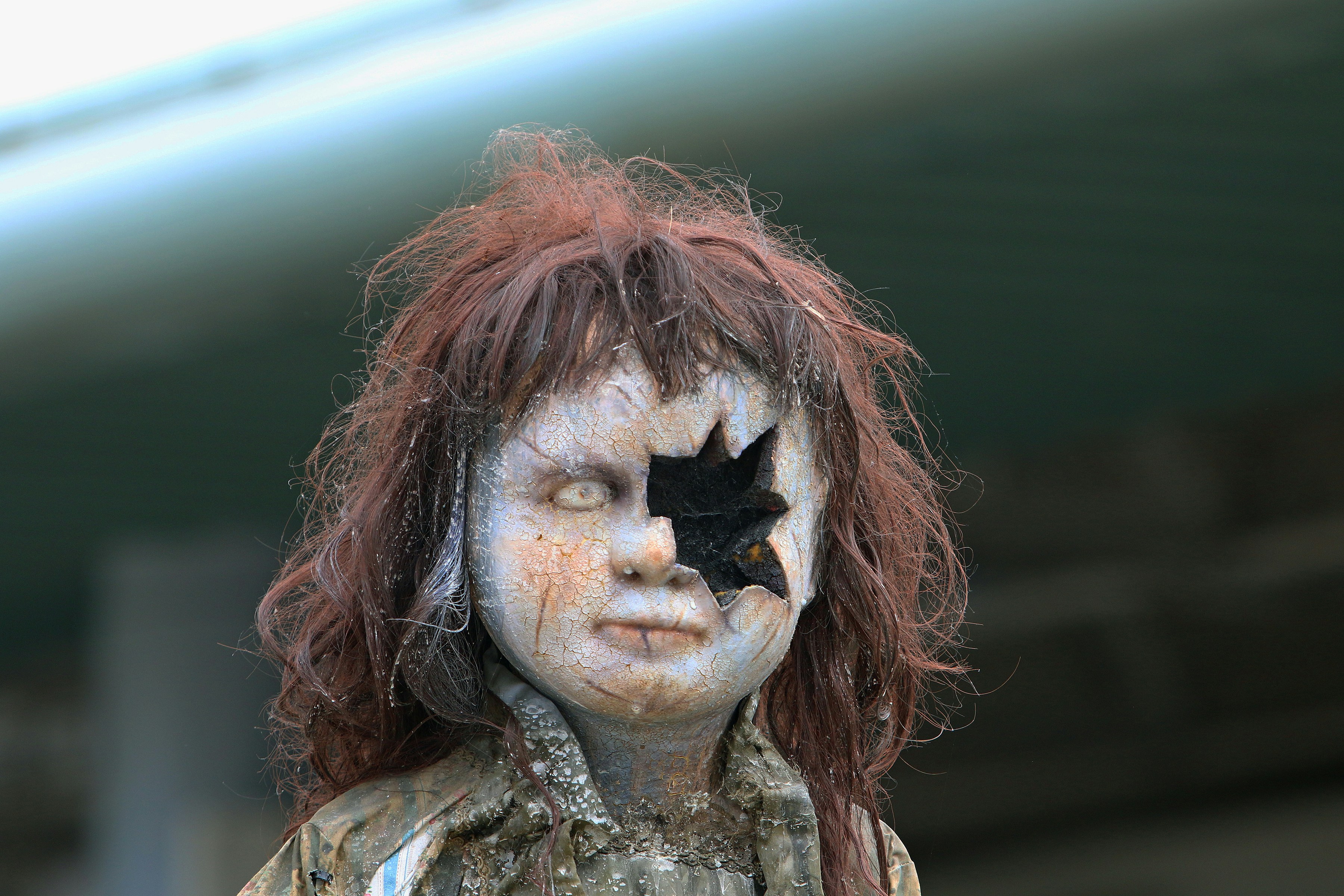 Creepy doll with damaged eye and messy hair