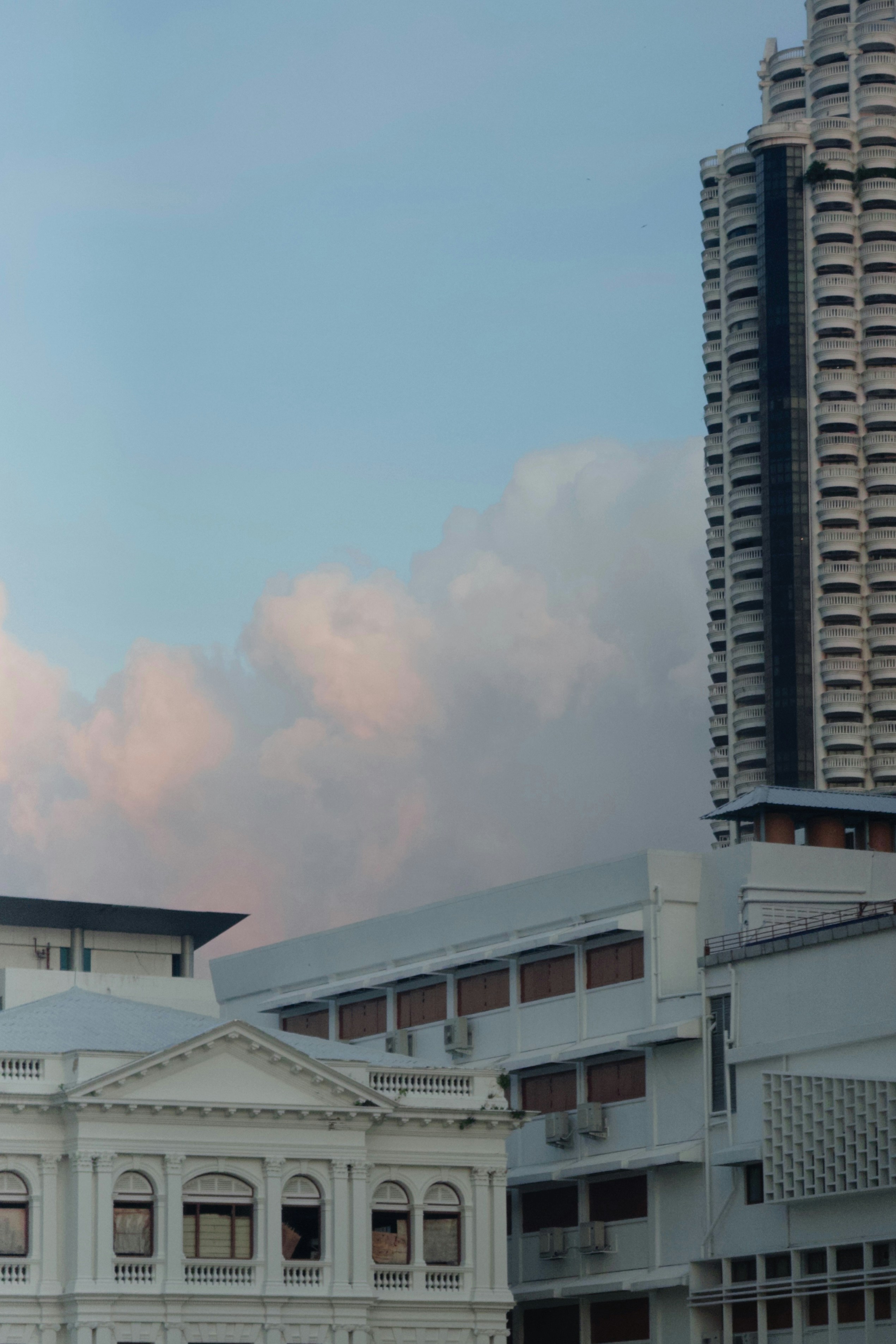 Modern and classical buildings against a cloudy sky
