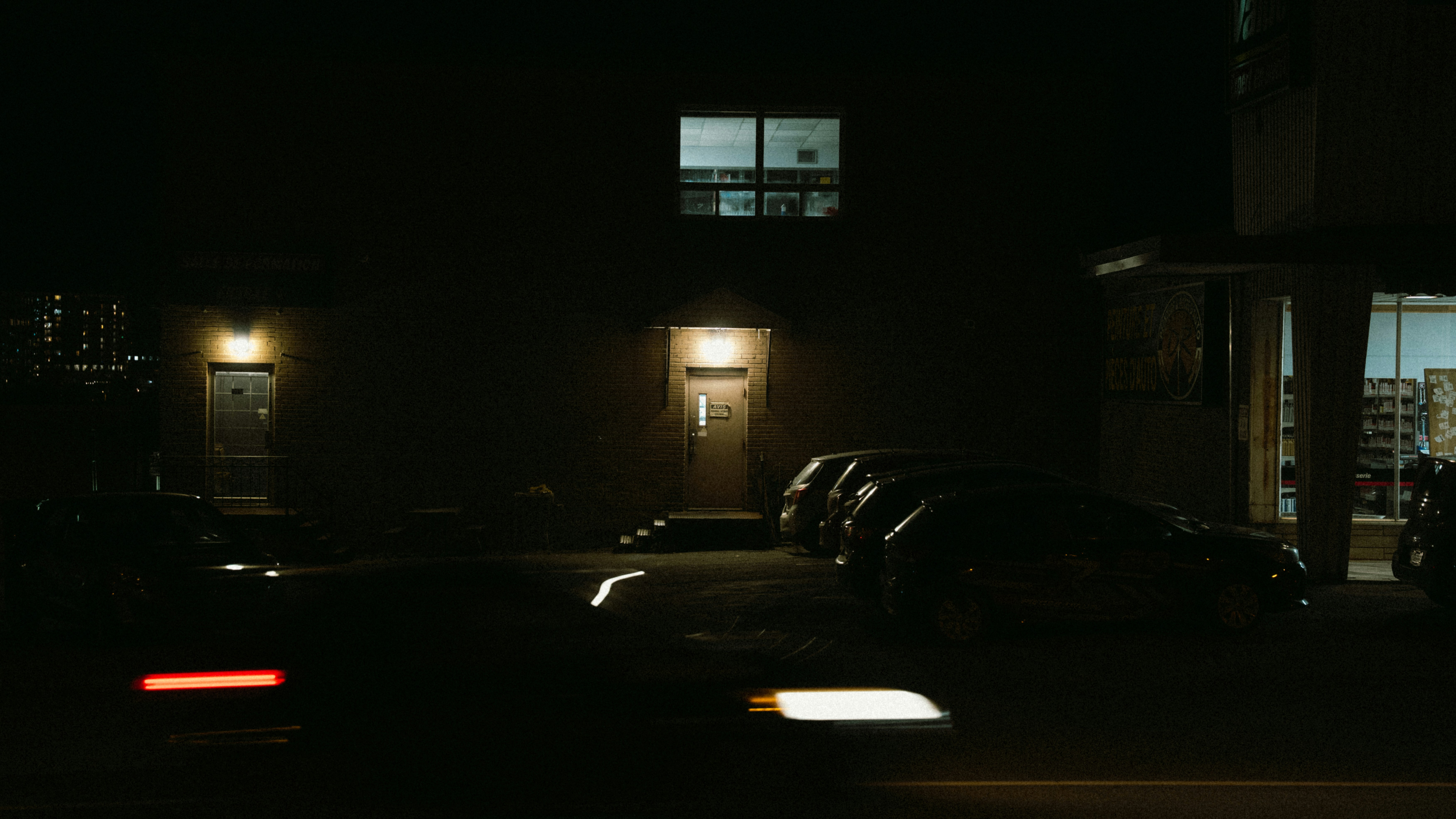 Cars parked outside a building at night
