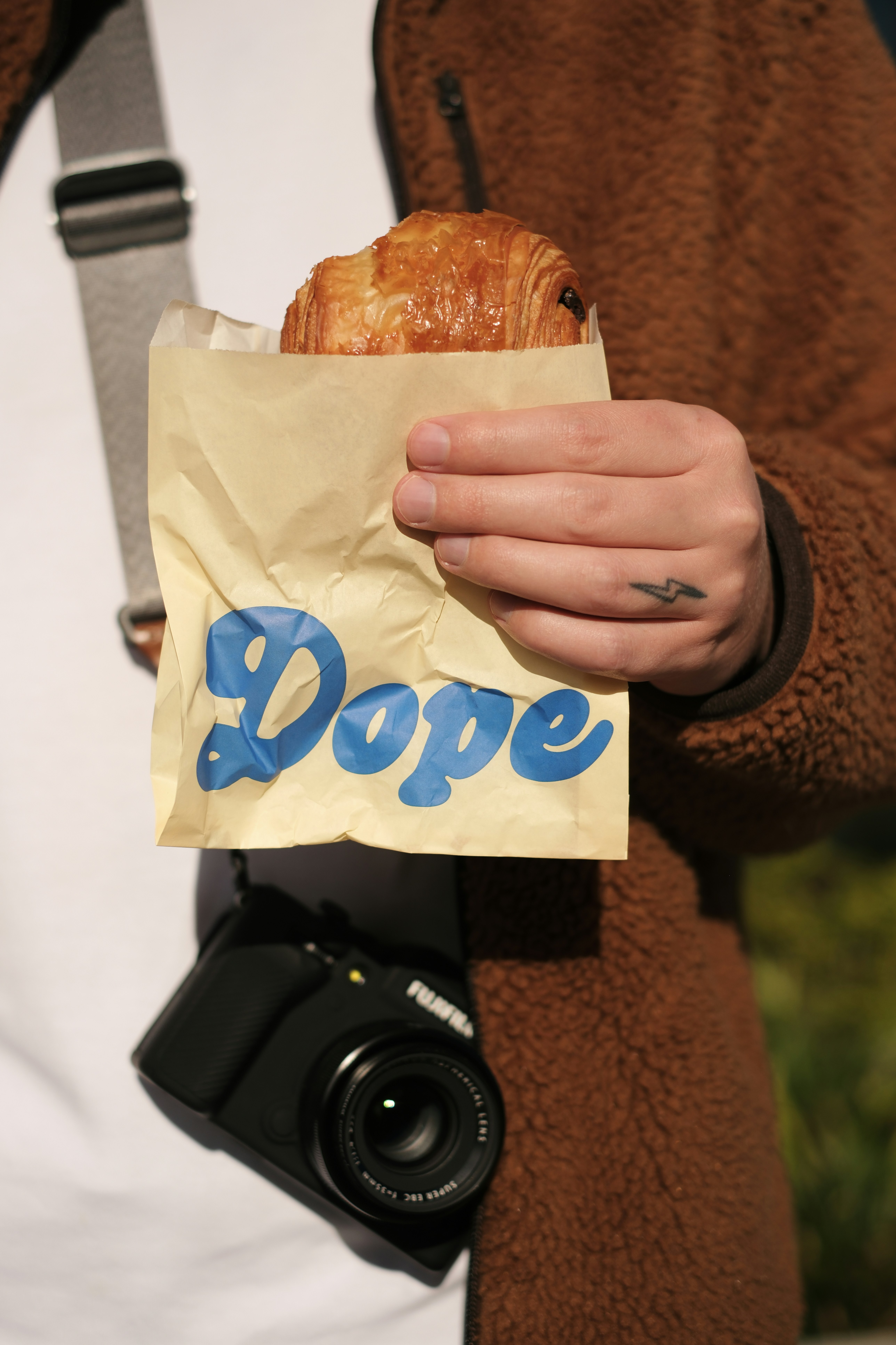 Instagram - @kaprion | Person holding a croissant in a paper bag