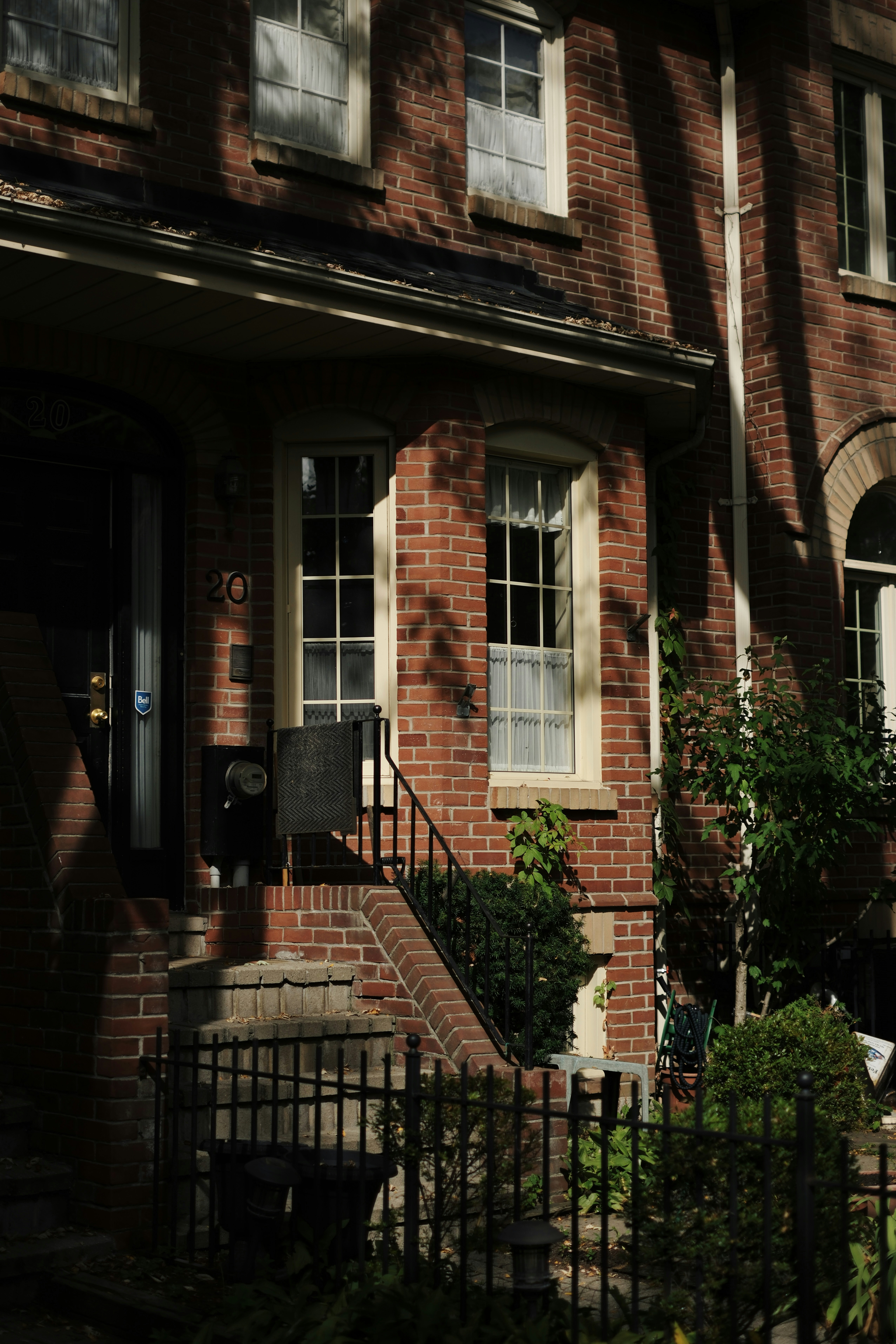 Instagram - @kaprion | Brick row houses with white windows and shadows.