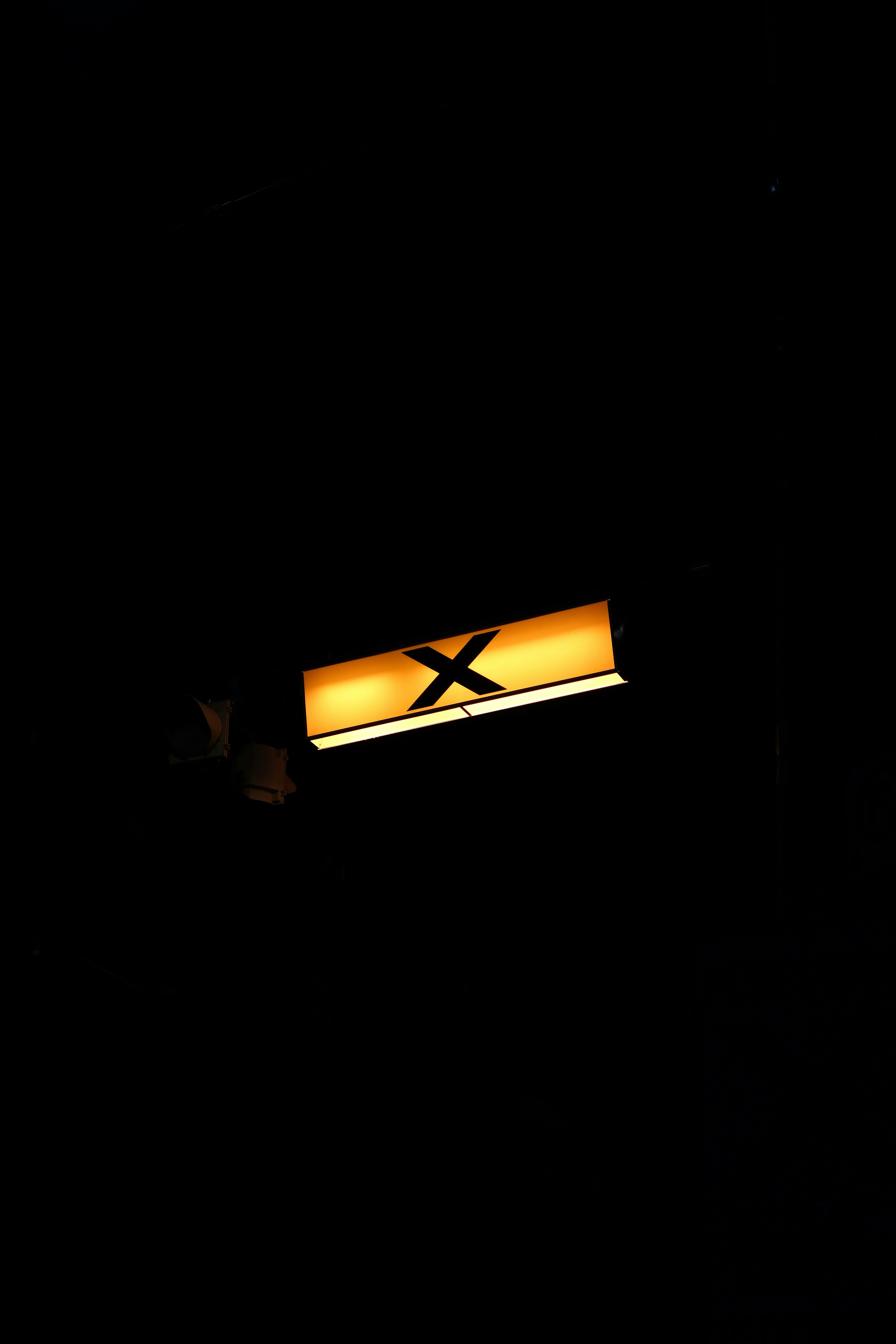 Illuminated Letter X in Urban Darkness