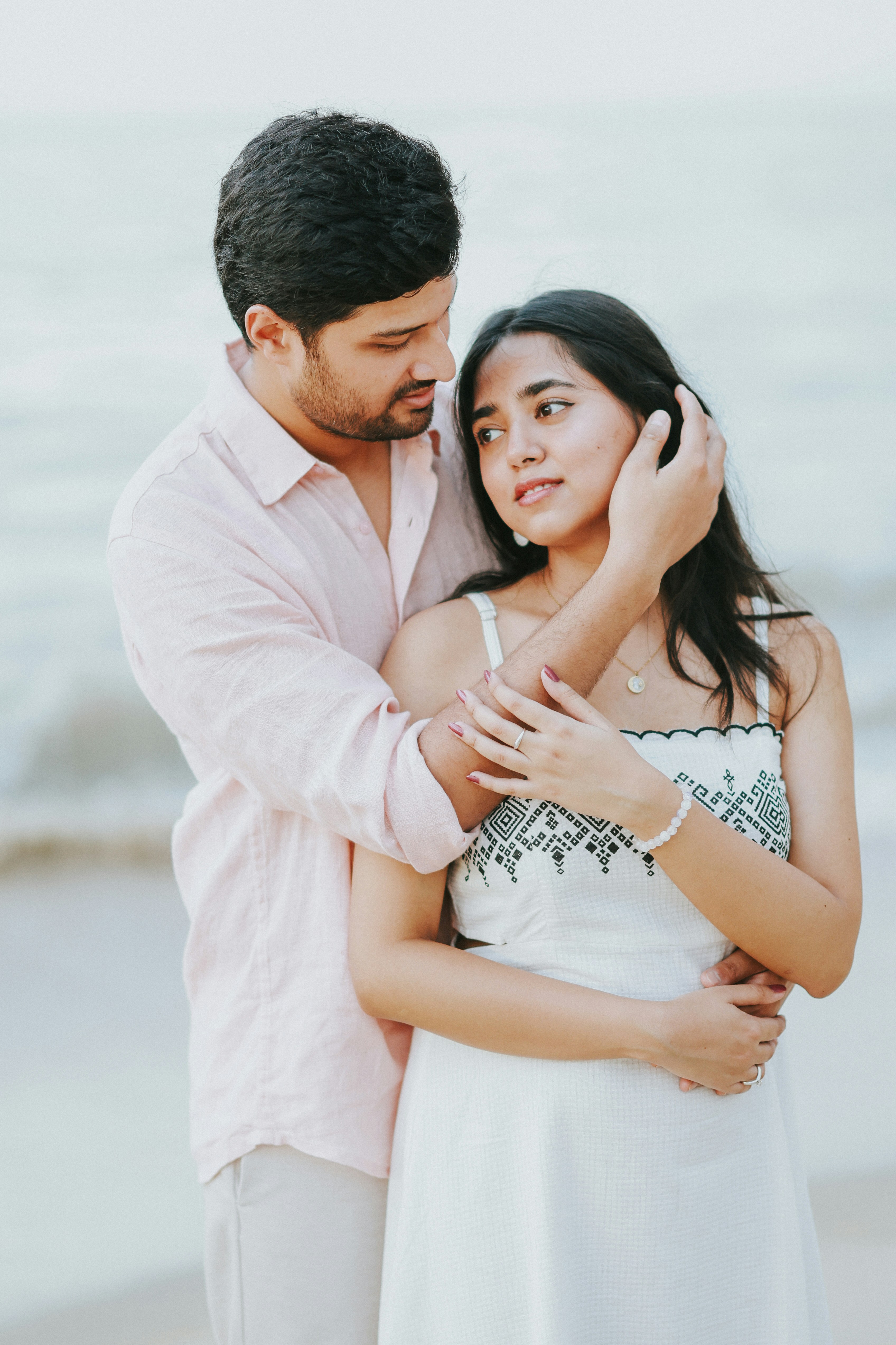 Couple embracing on a beach at sunset