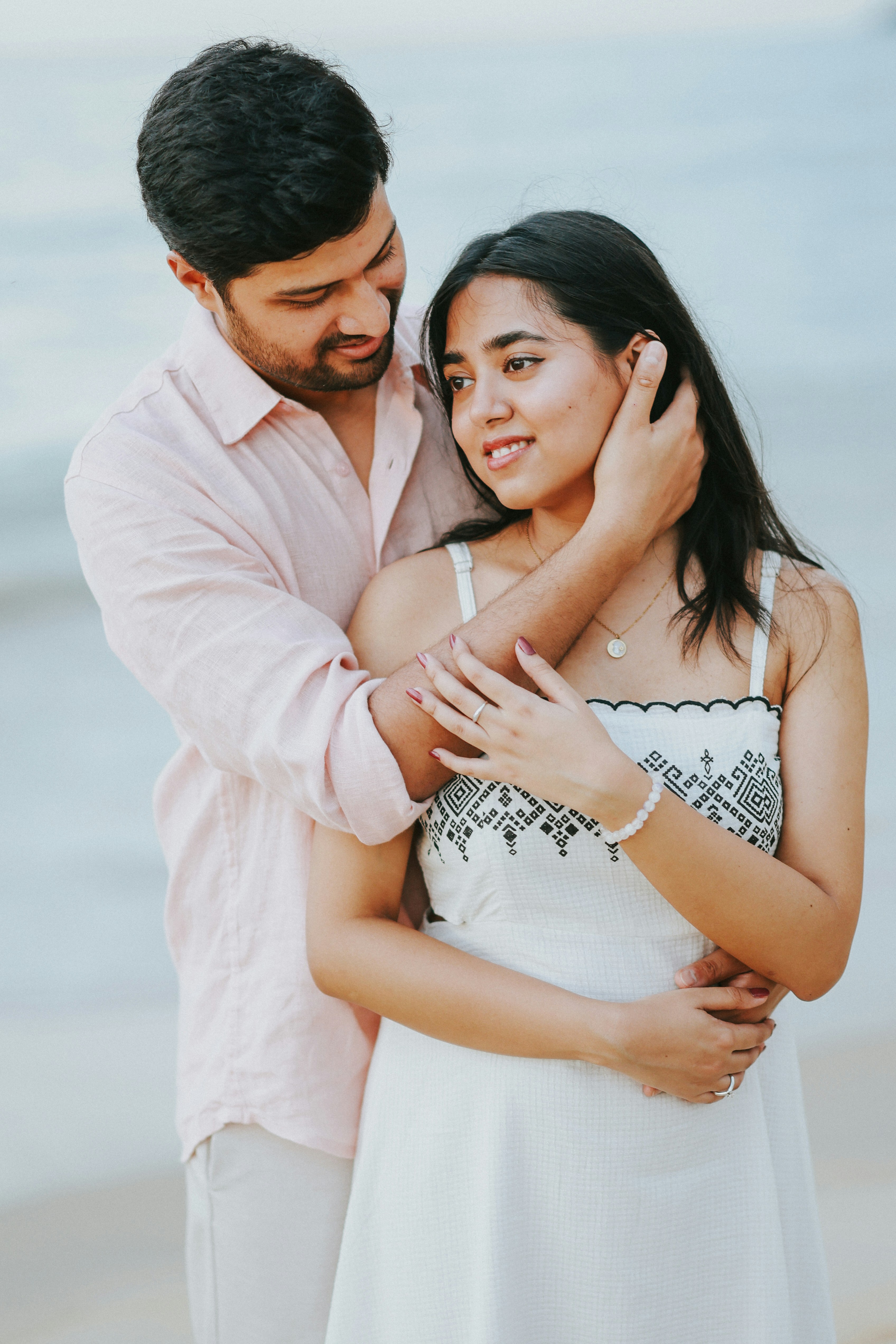 Couple embracing on a beach at sunset