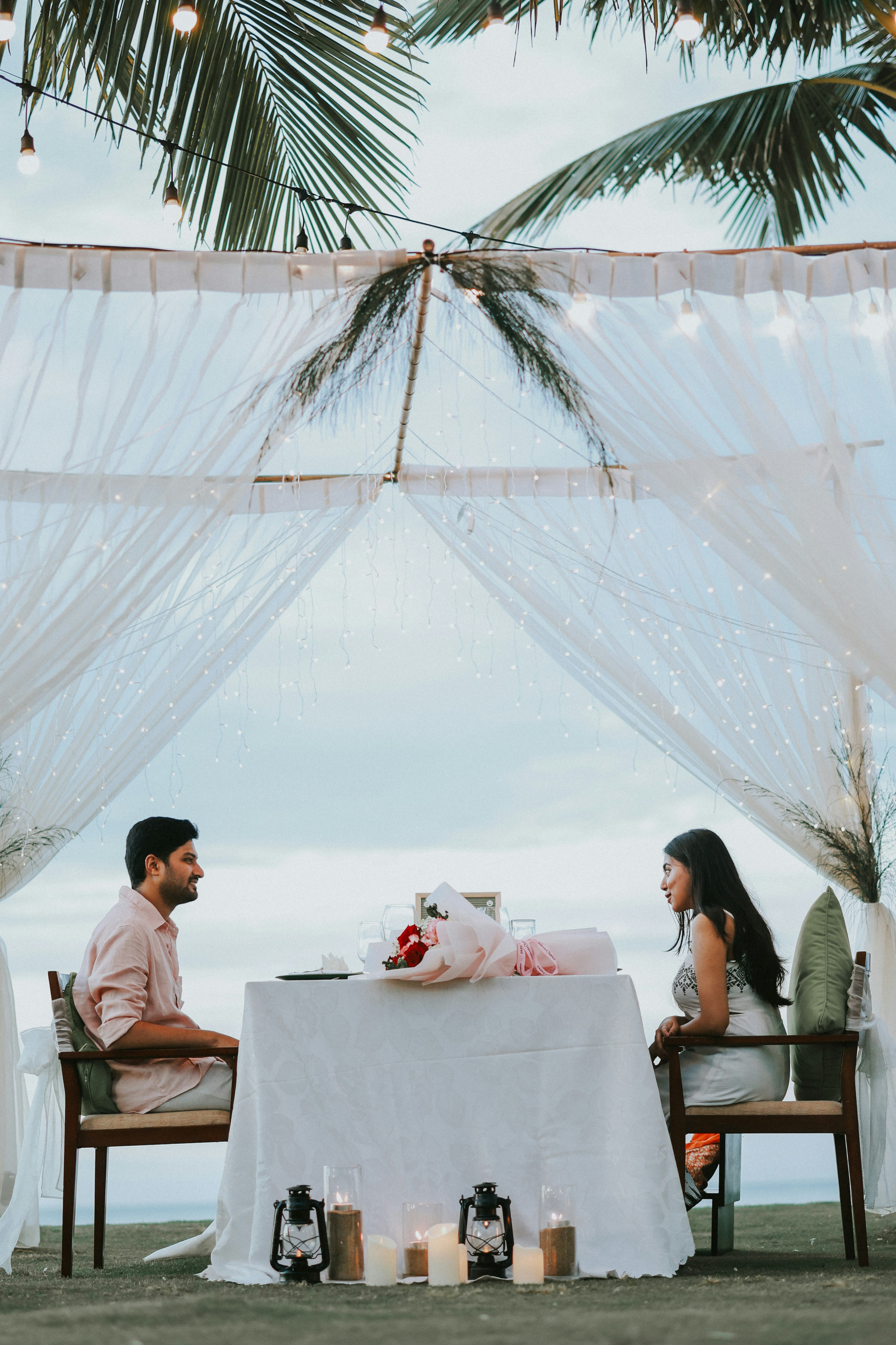 Couple having a romantic dinner by the ocean.
