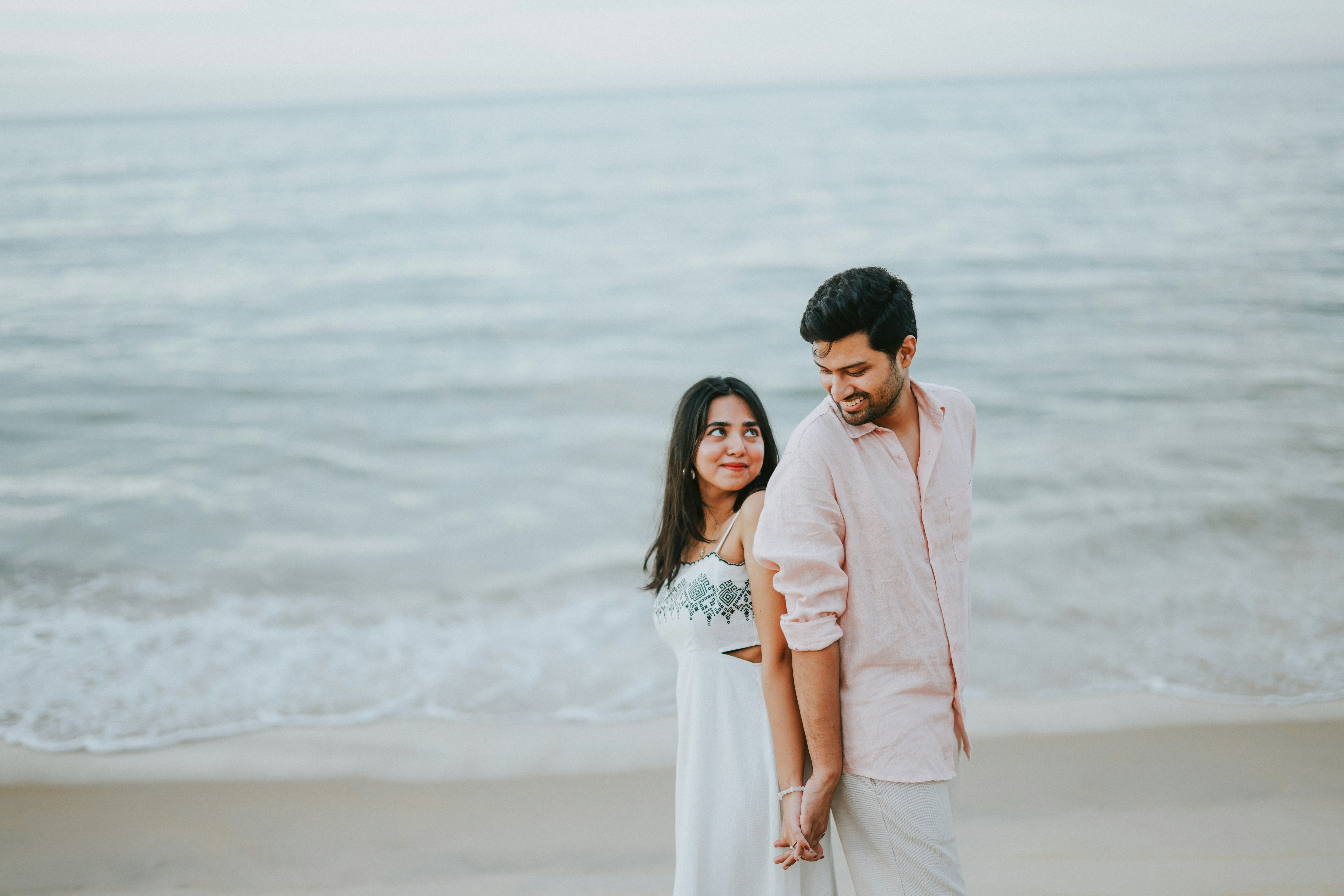 Couple holding hands on a beach