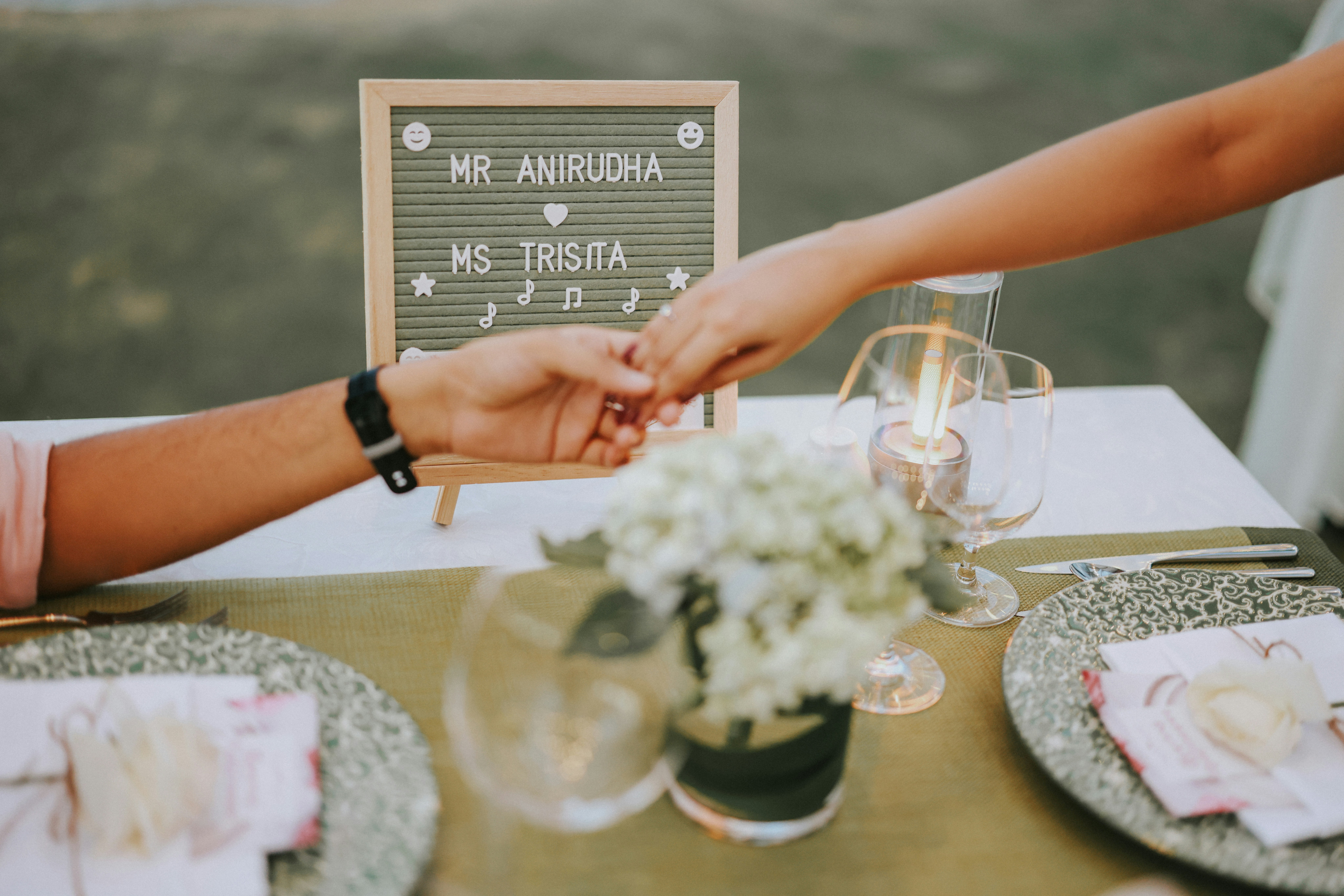 Couple holding hands at a table with names