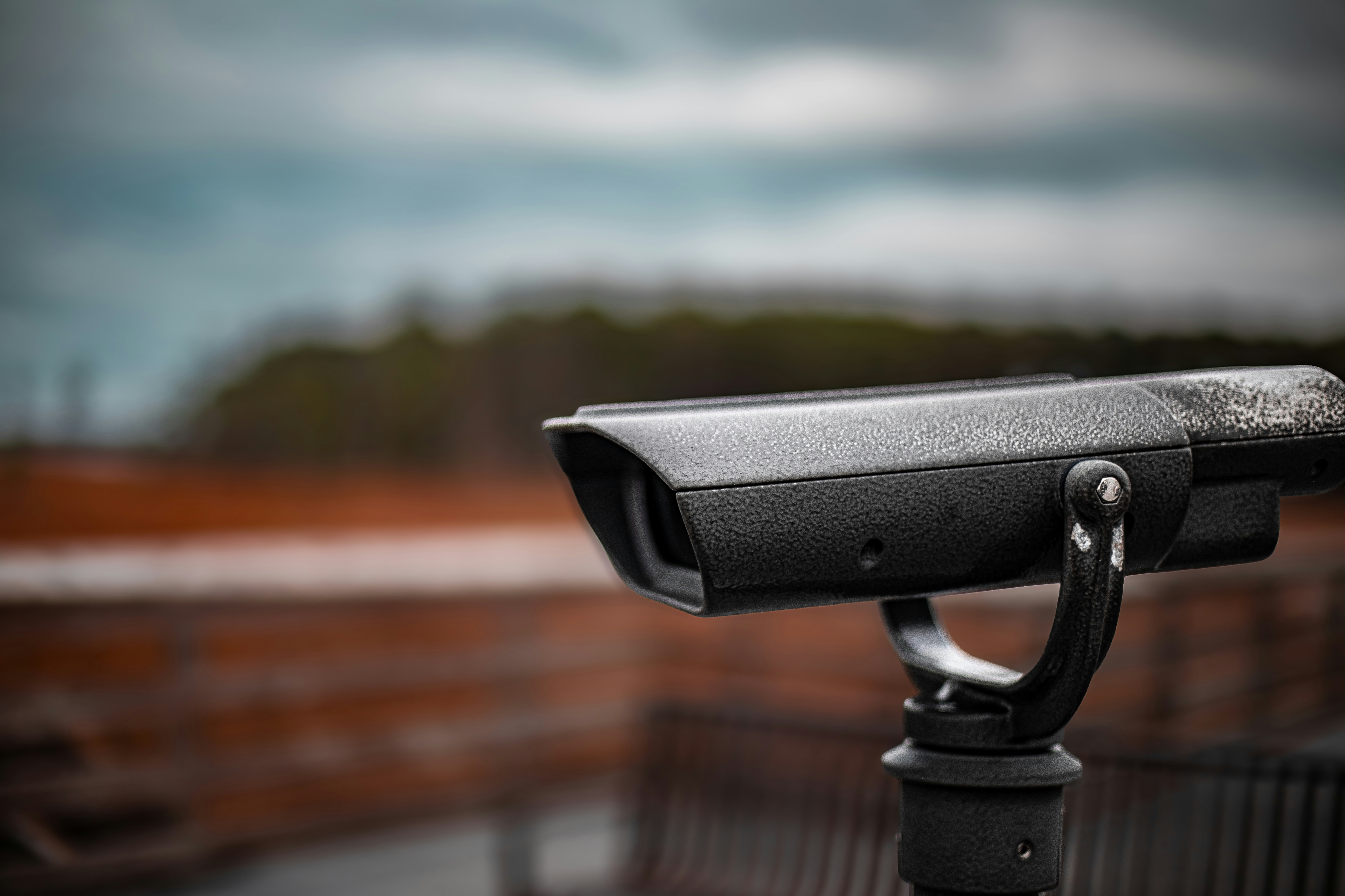 A telescope mounted on a stand, poised to offer views of distant landscapes under a moody sky.