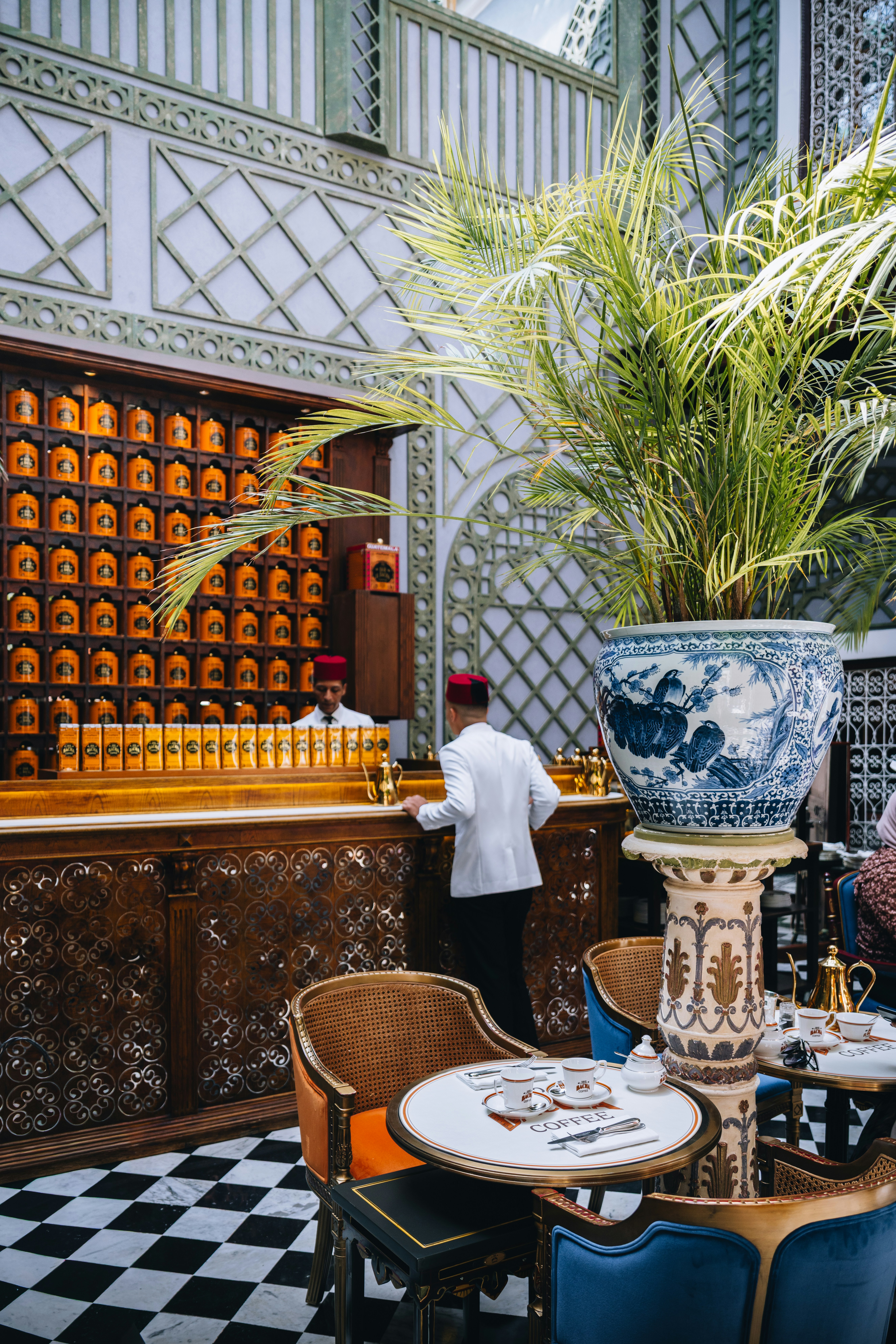 Two men in uniform behind a tea counter photo – Free Aesthetic Image on ...