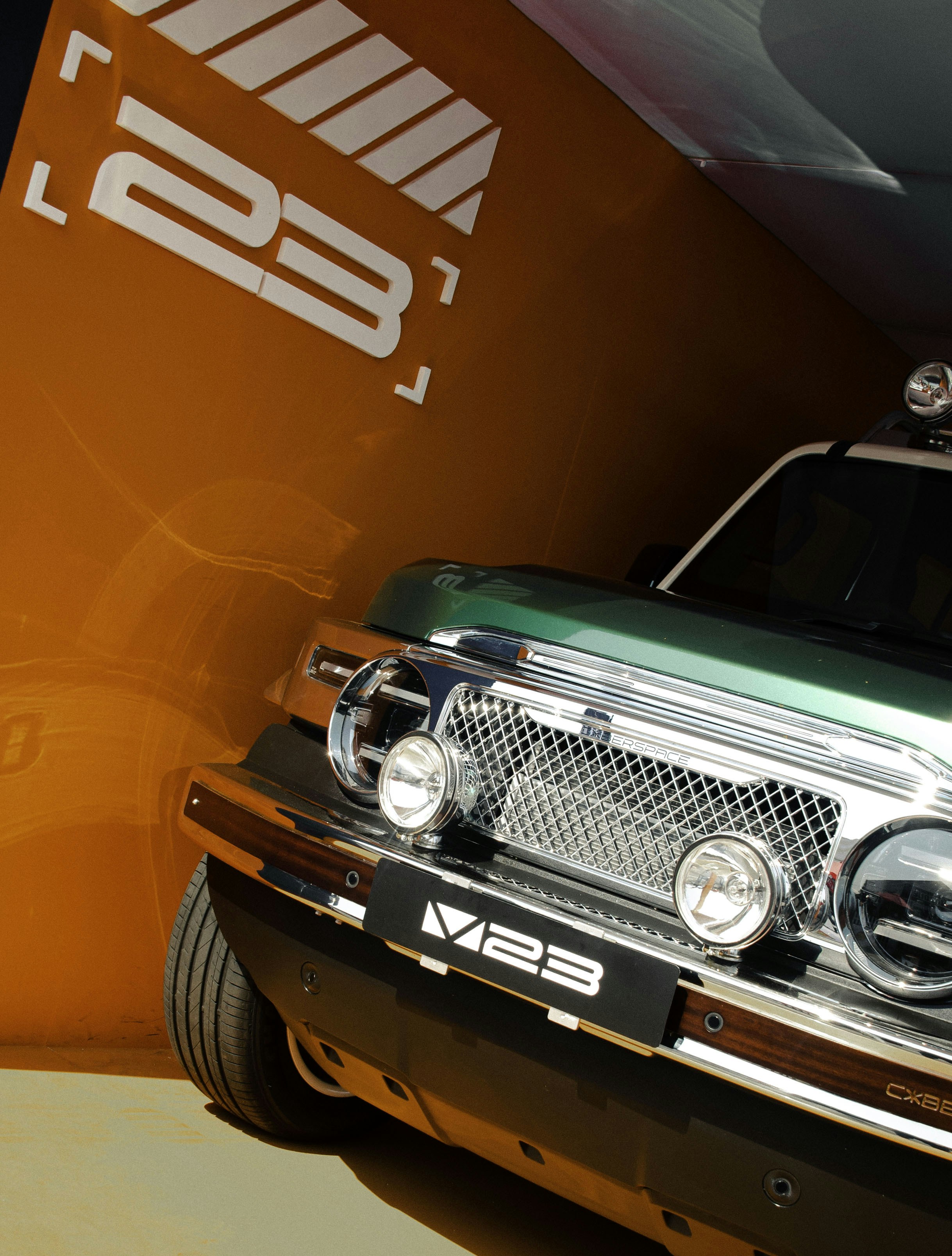 Verdant Retro SUV Confronts a Bold Orange Backdrop