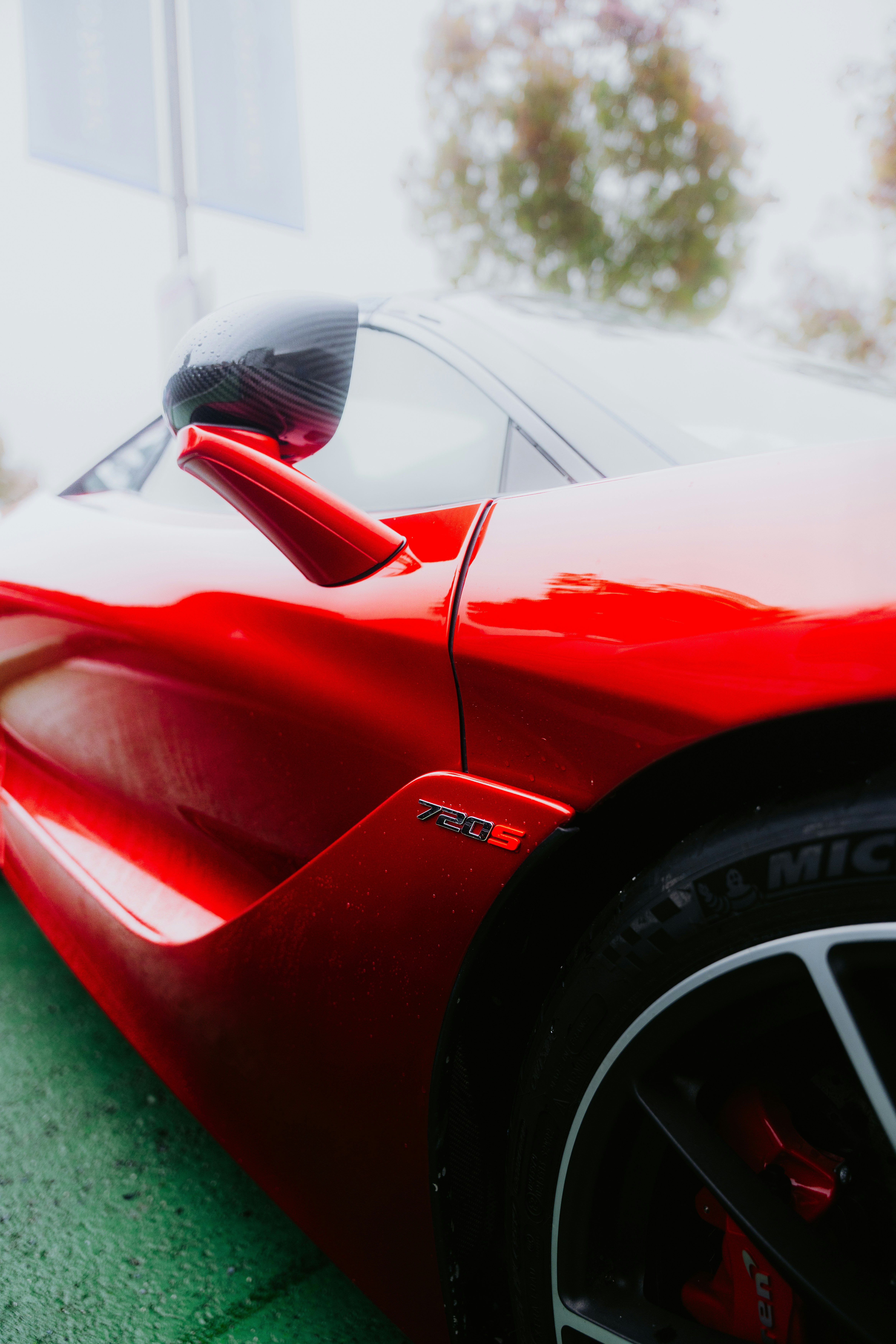 Red sports car with black accents and silver wheels.