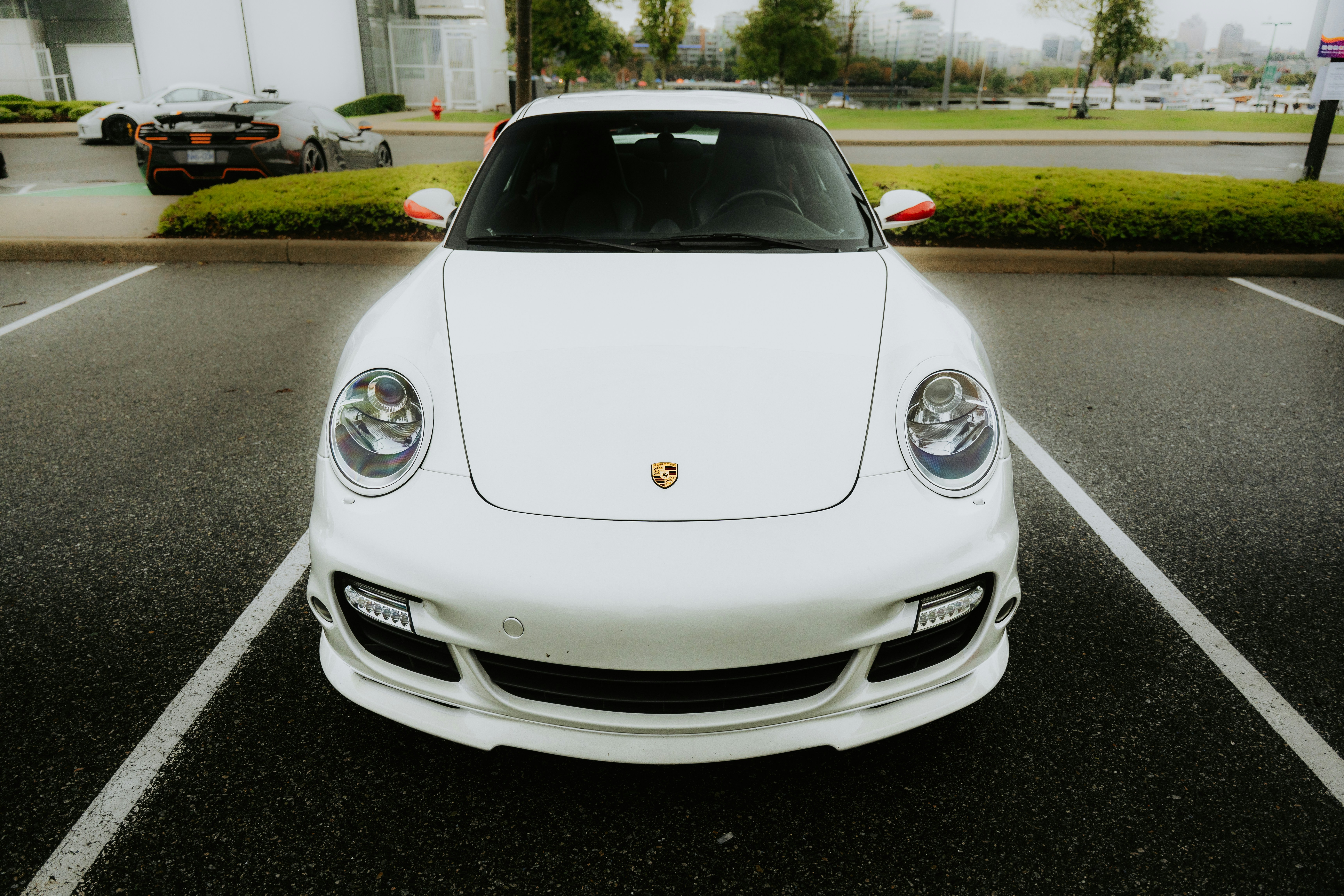 White porsche parked in a parking lot